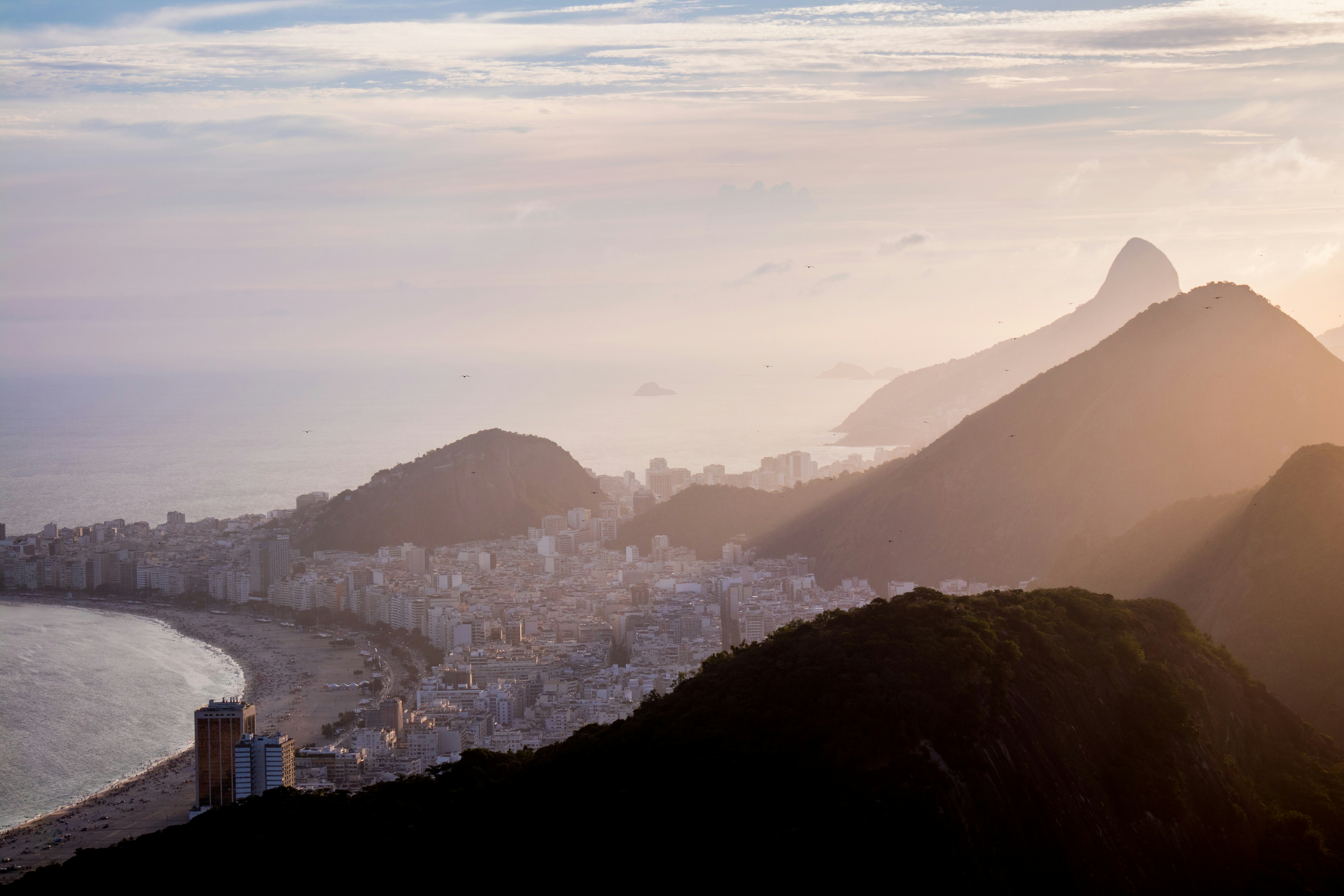 Rio de janeiro cityscape and beach with mountains at sunset.
