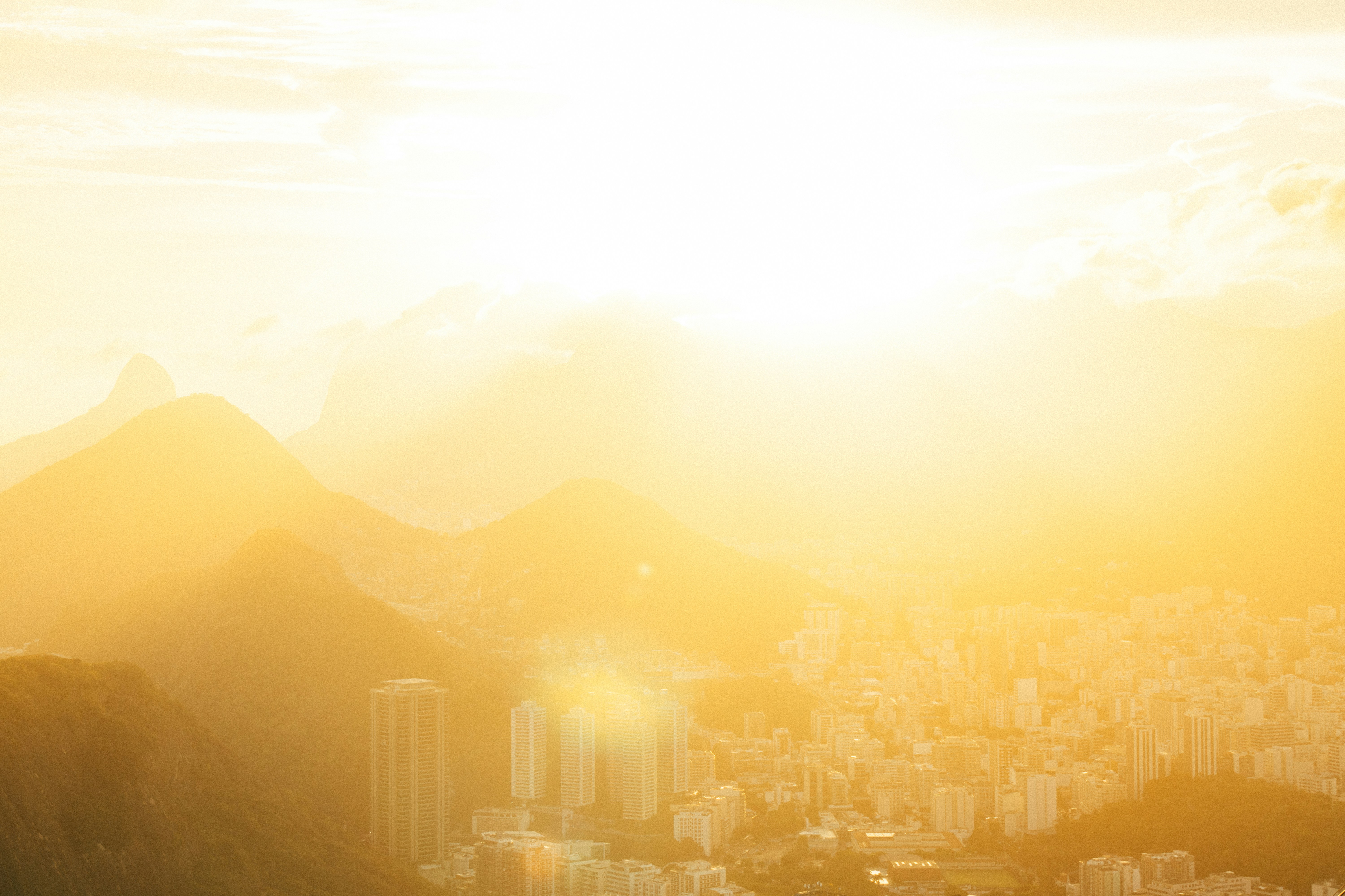 City Under a Sunlit Veil: A Distant Skyline in Golden Hour