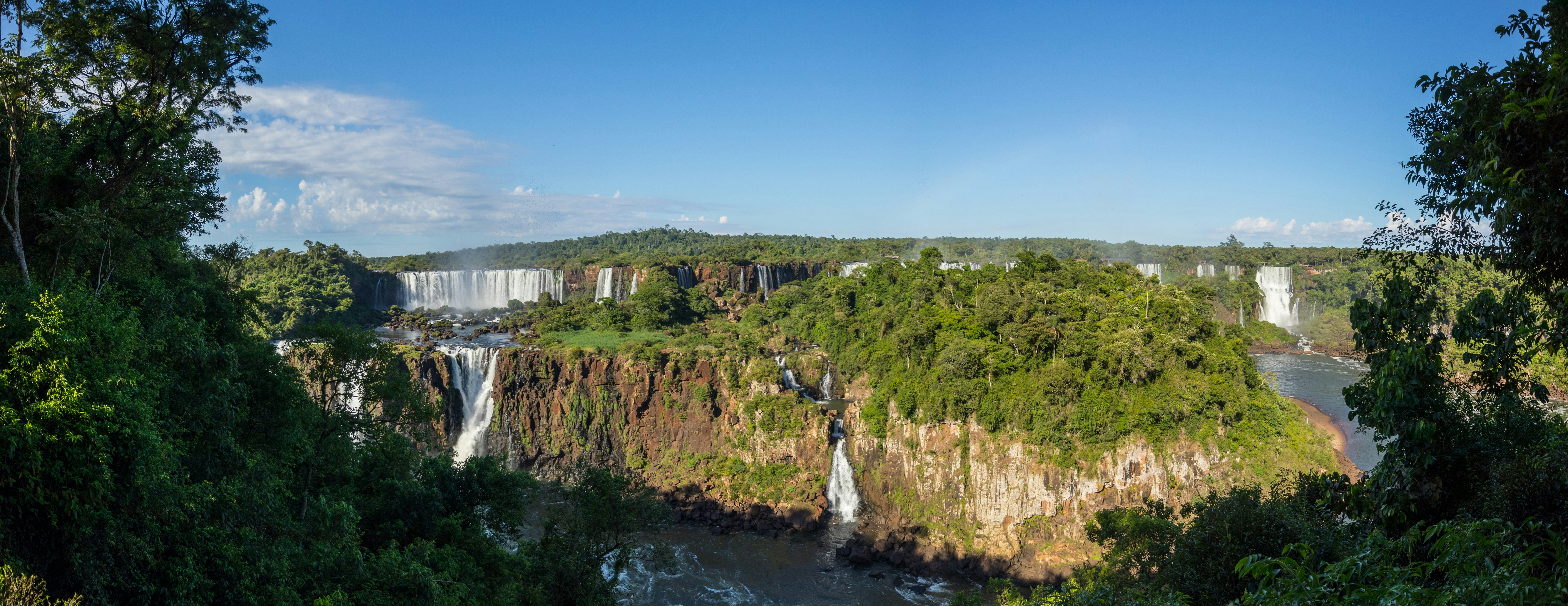 Panorama of cascading Iguazu-like Falls framed by Lush Greenery