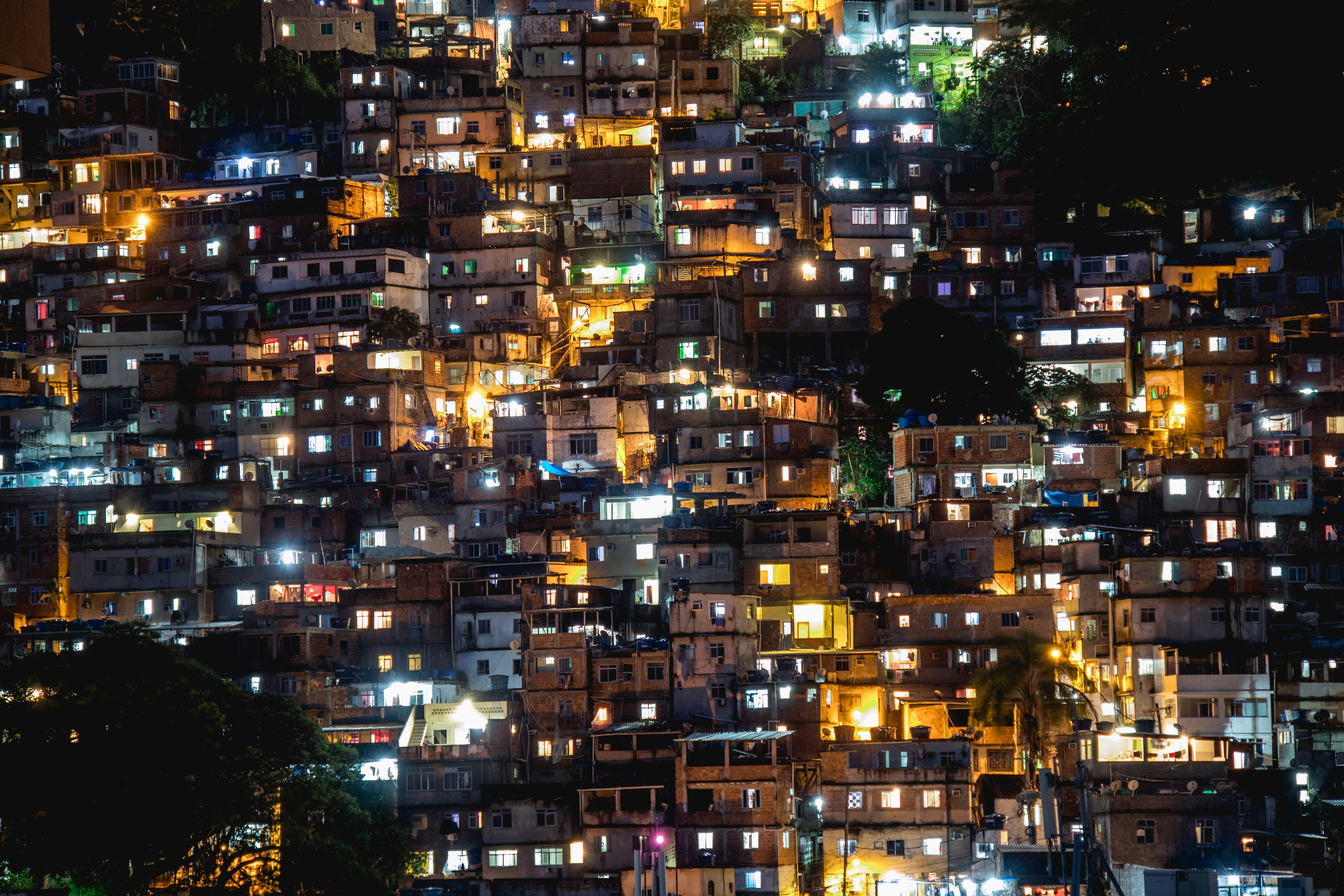 Densely packed buildings with illuminated windows at night.