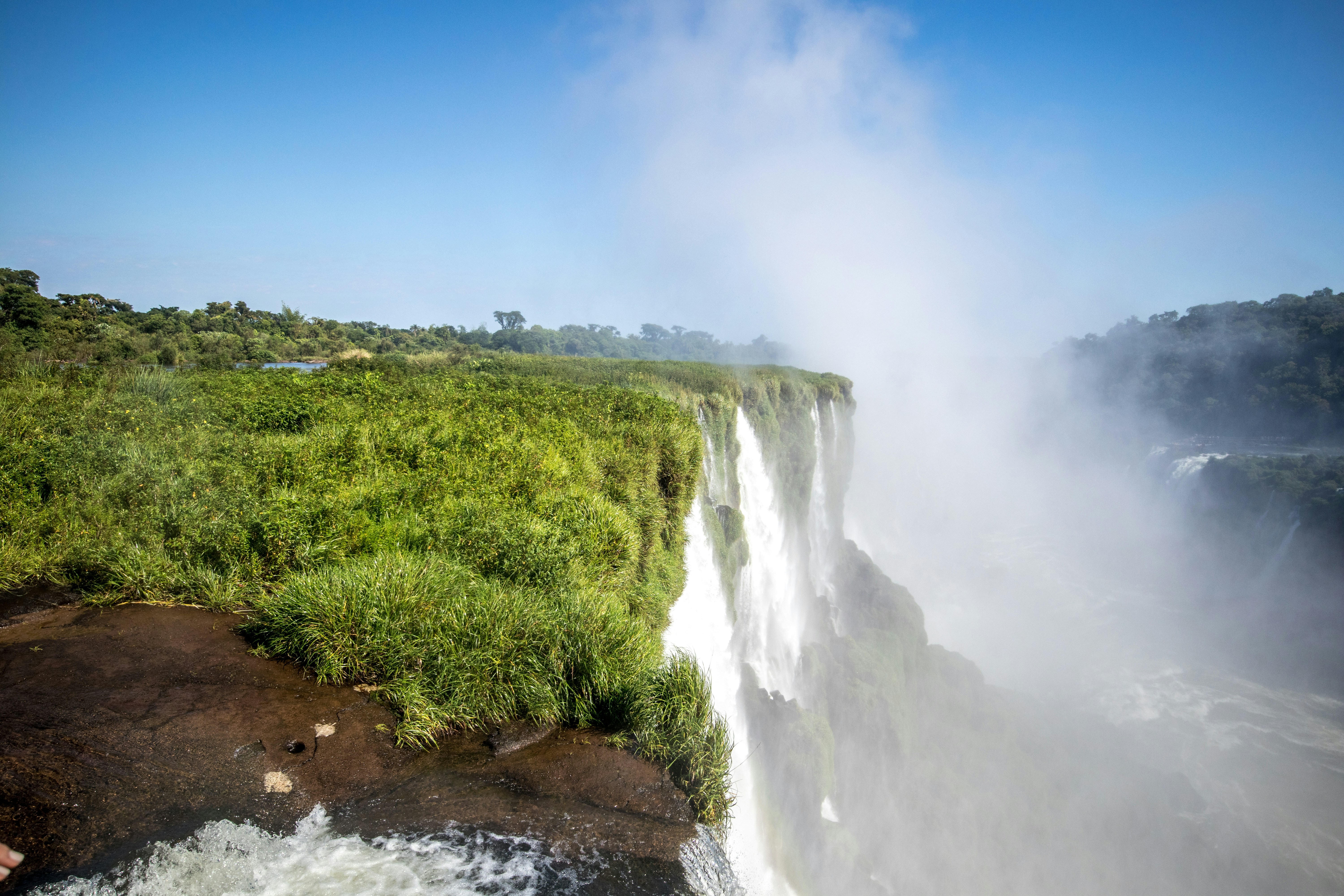 Misty Cascade at the Edge of Green Cliffs