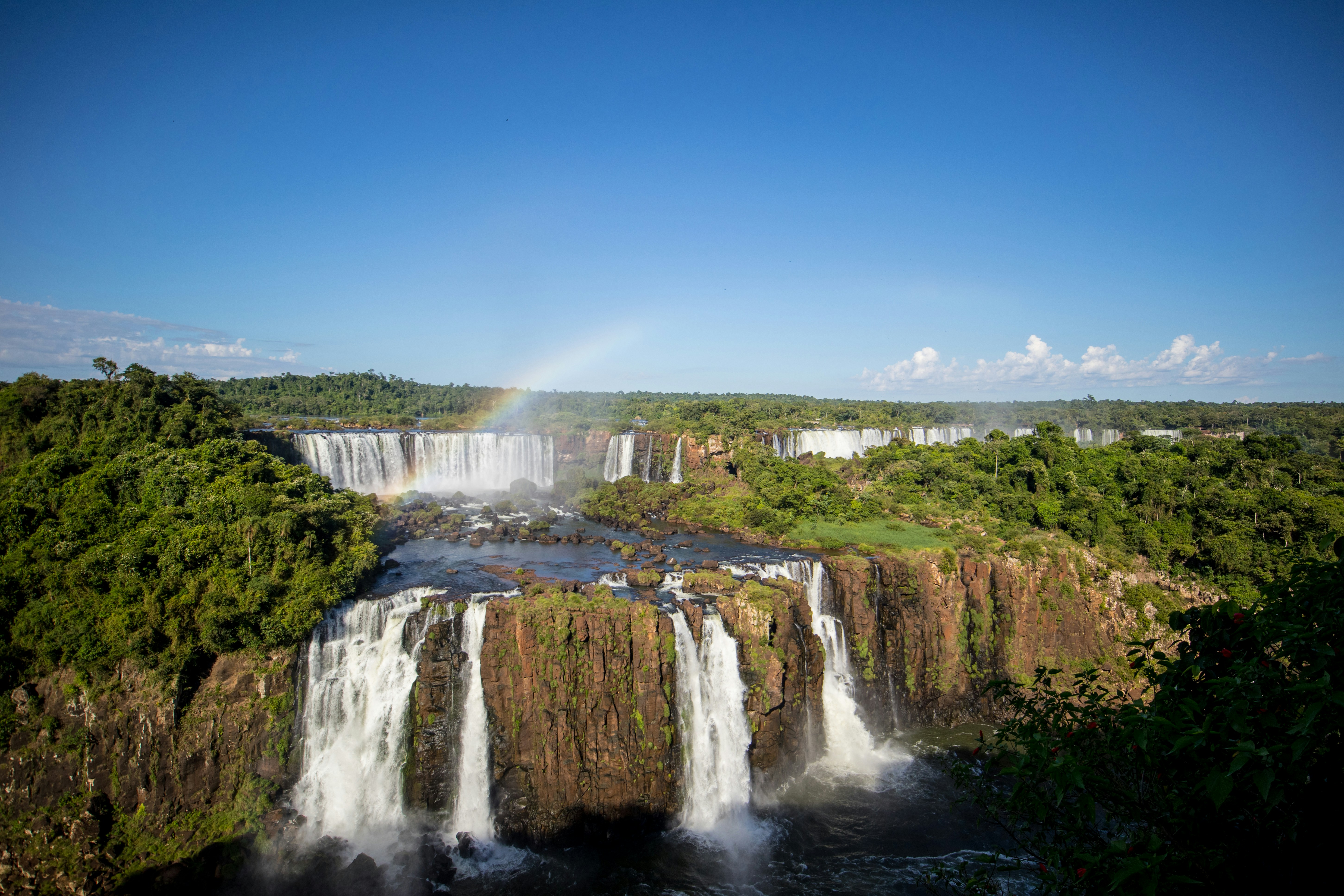 Rainbow over the Iguazu Mist: A Wide-Vista of Cascading Falls