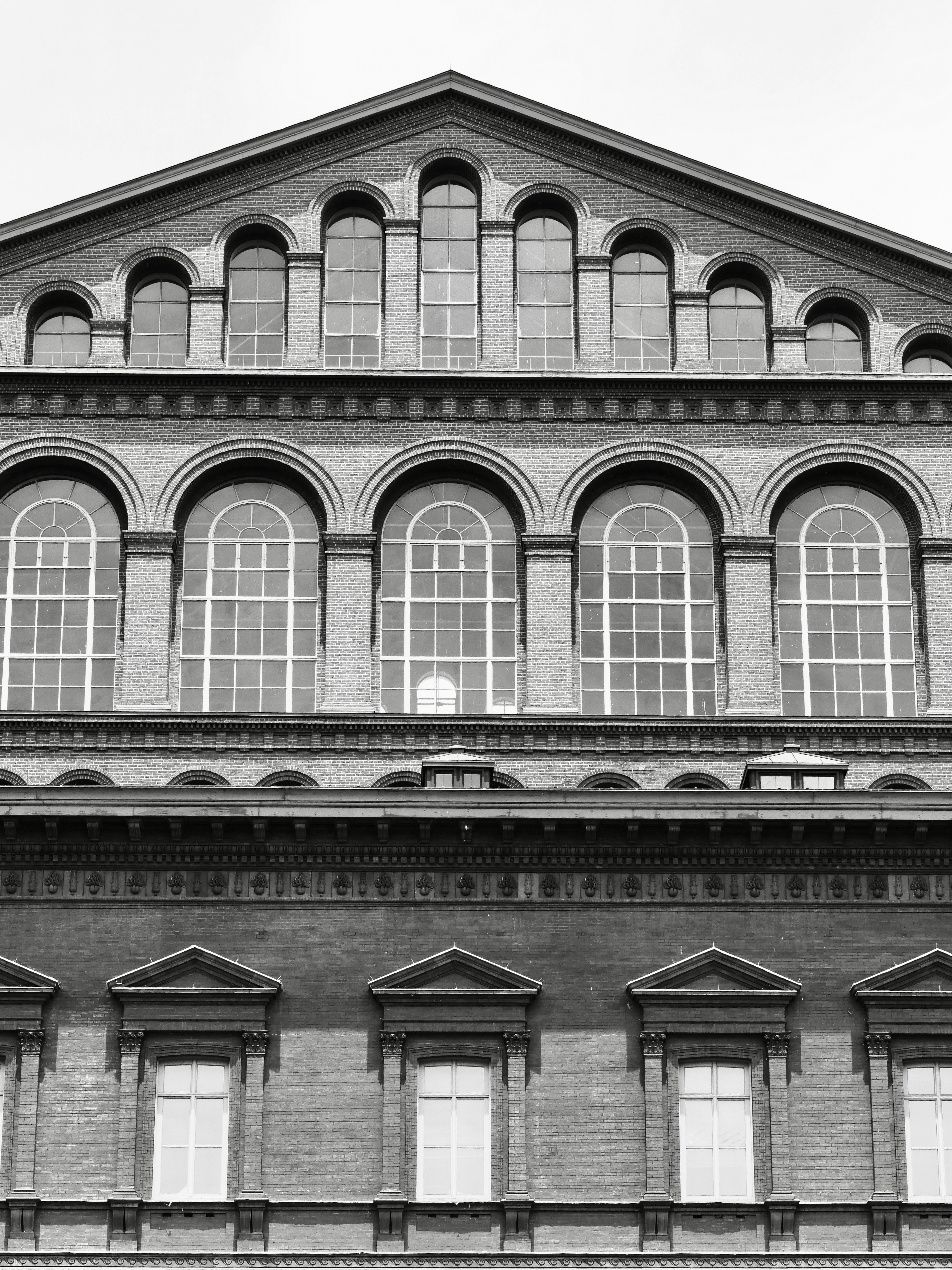 Symmetrical Brick Facade: Arched Windows as Architectural Chorus
