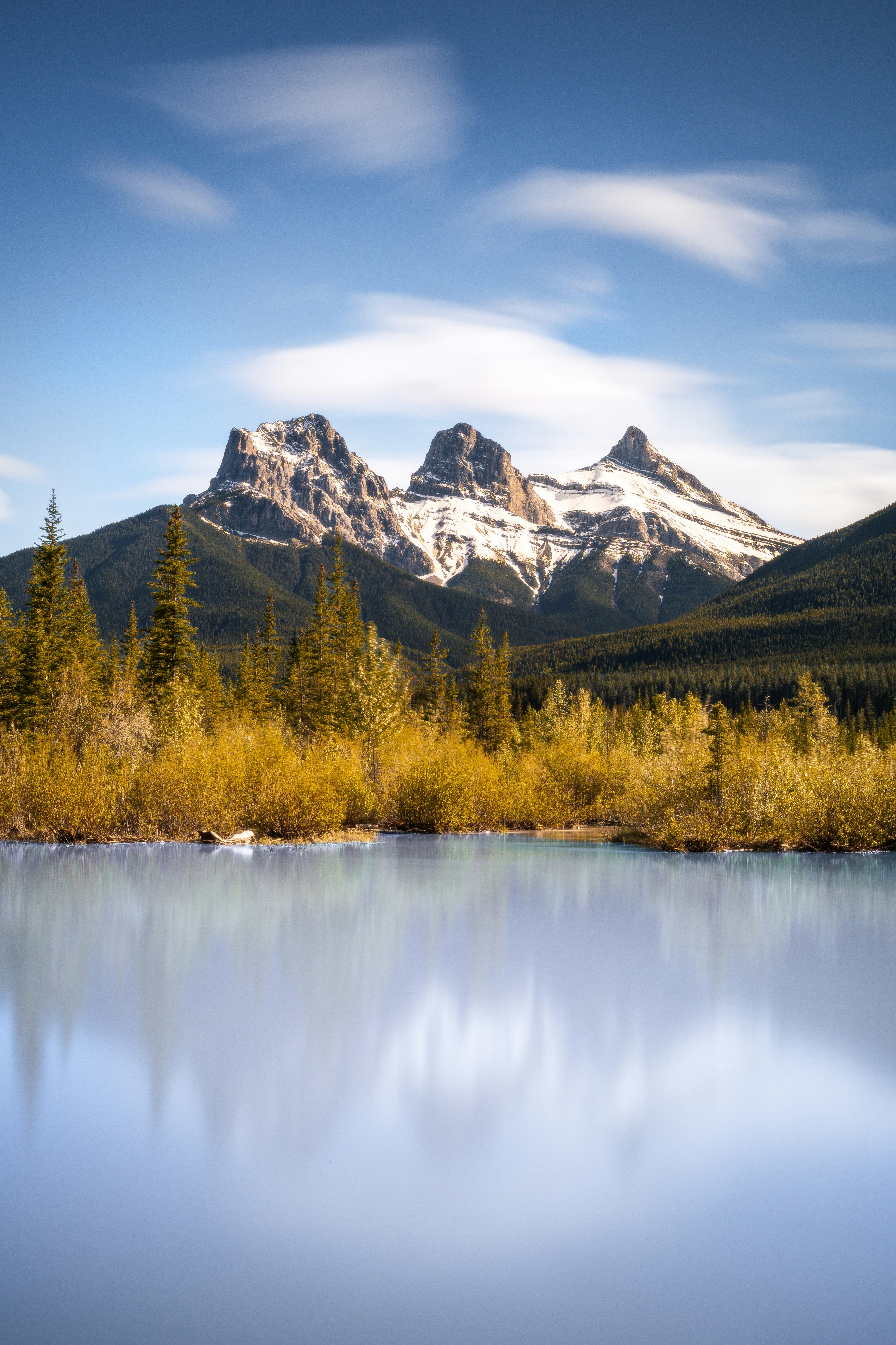 Snow-topped Peaks Above Golden Pines and Serene Waters