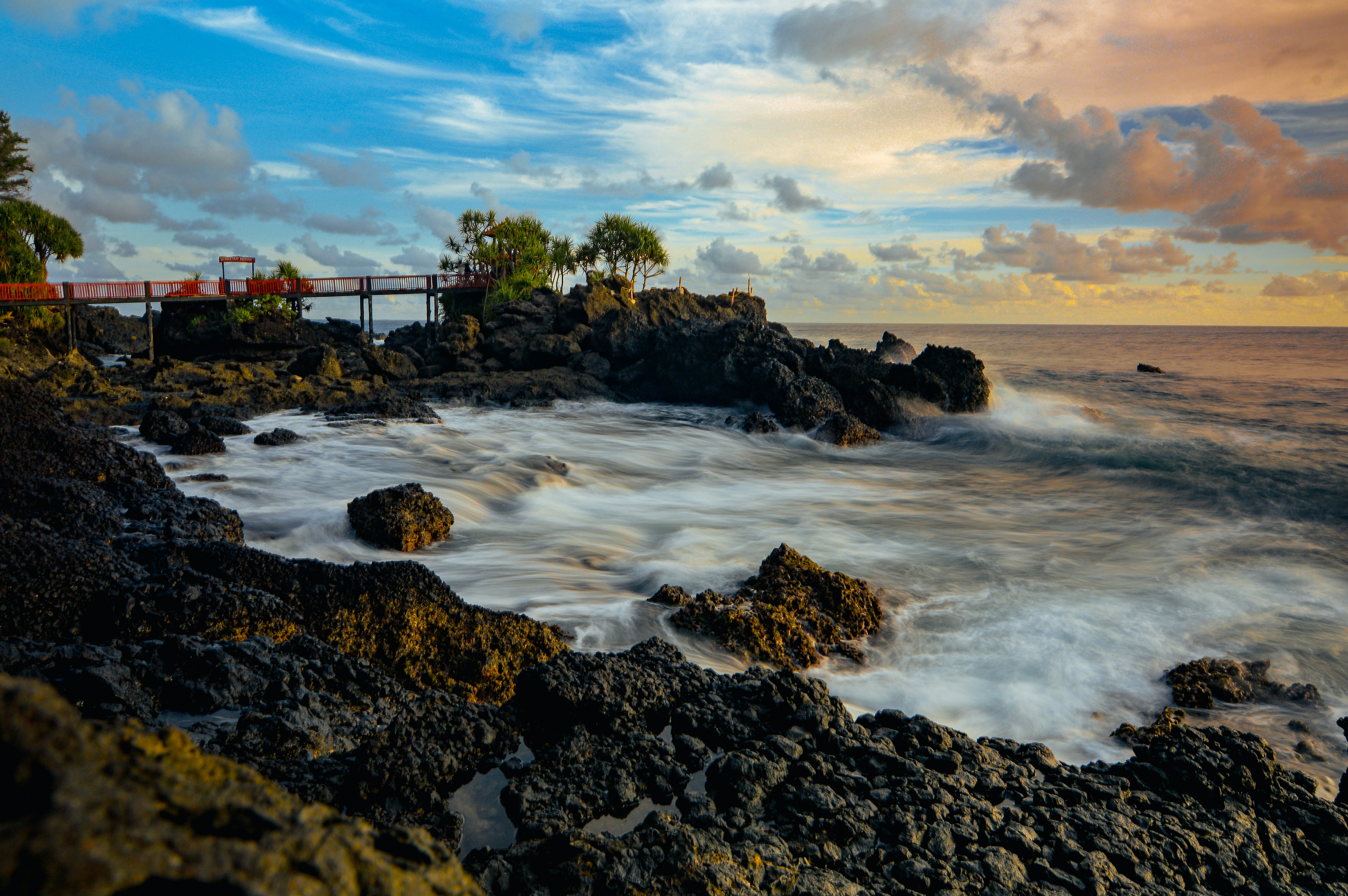 Sunlit Rocks and Streamlined Sea: A Coastal Landscape at Dusk
