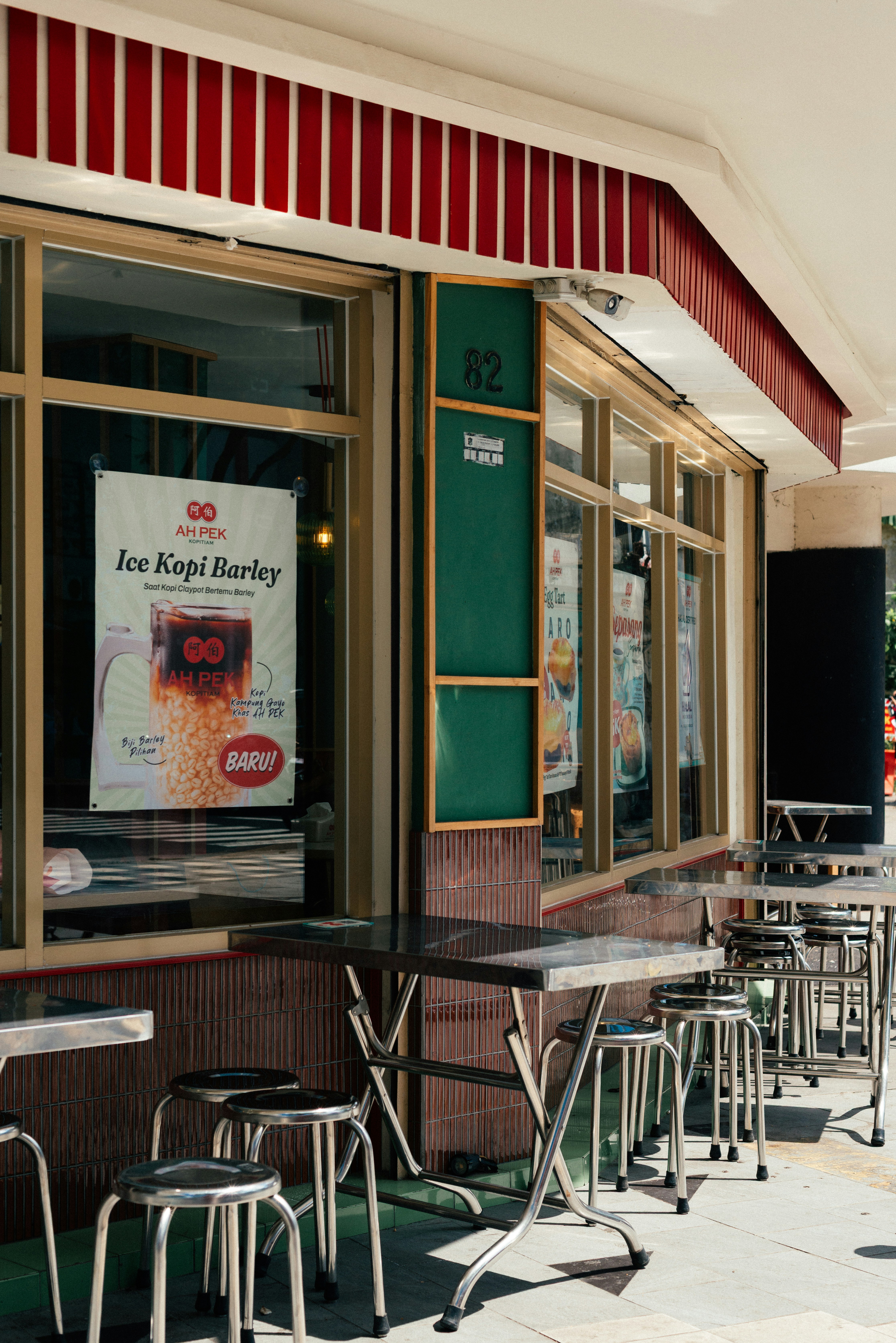 Cafe Front with Green Panel and Outdoor Seating