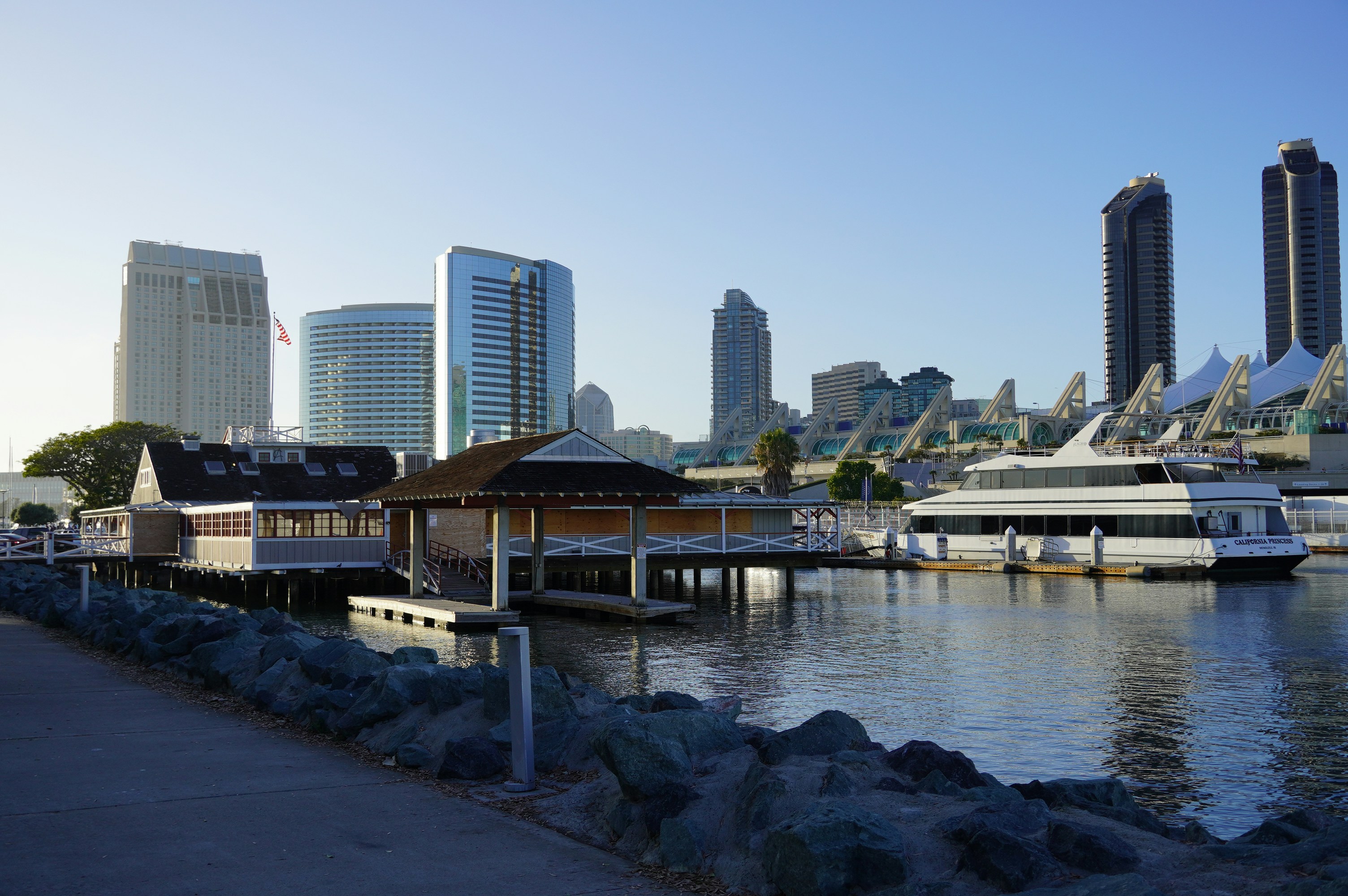 Harbor Promenade at Dusk: Glass Towers and Wooden Pier