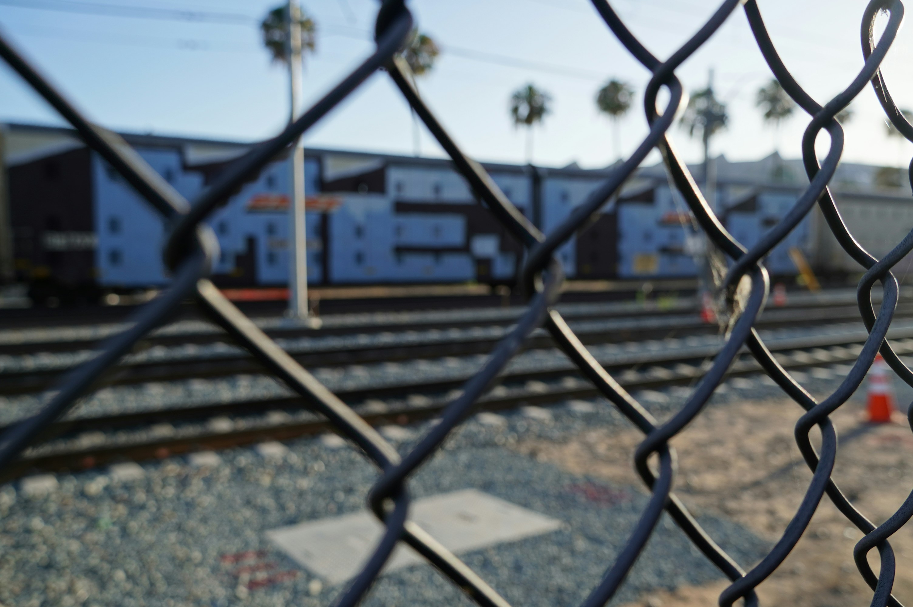 Through the Chain: Tracks Behind a Fenced Barrier