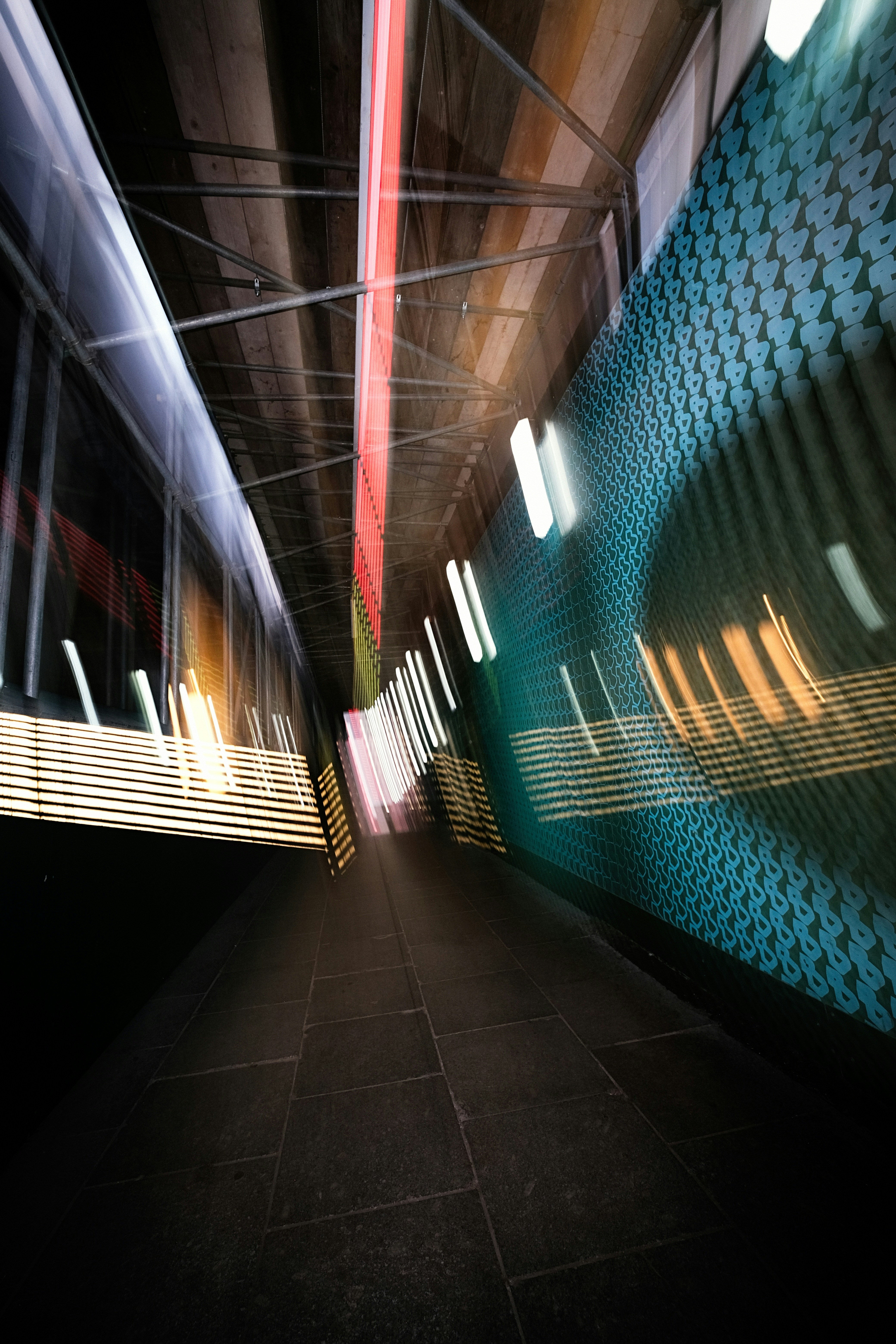 Neon Corridor in Motion: Blurred Lights and Geometric Walls