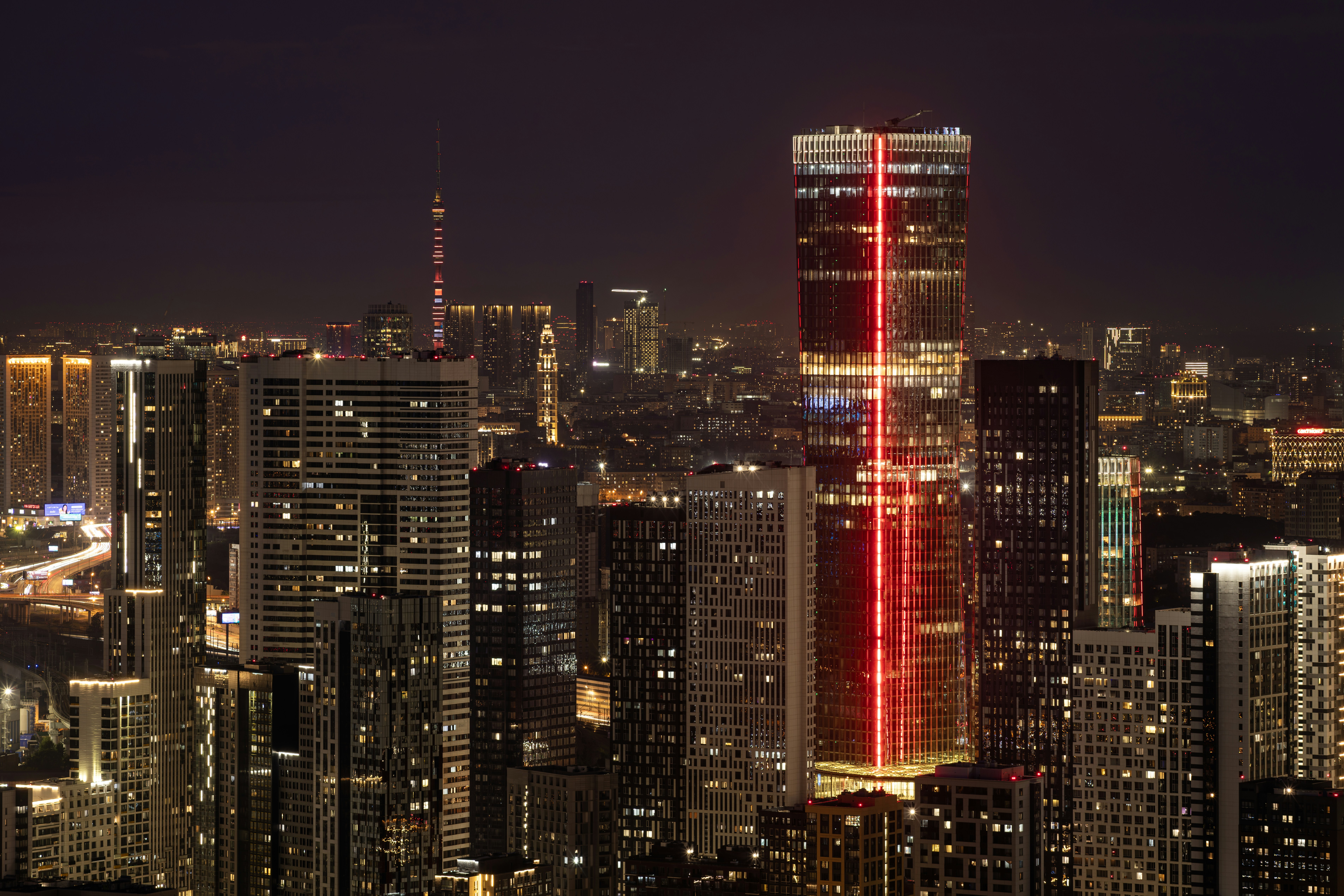 Vertical Neon Spine: Nighttime Skyline with a Tower of Light
