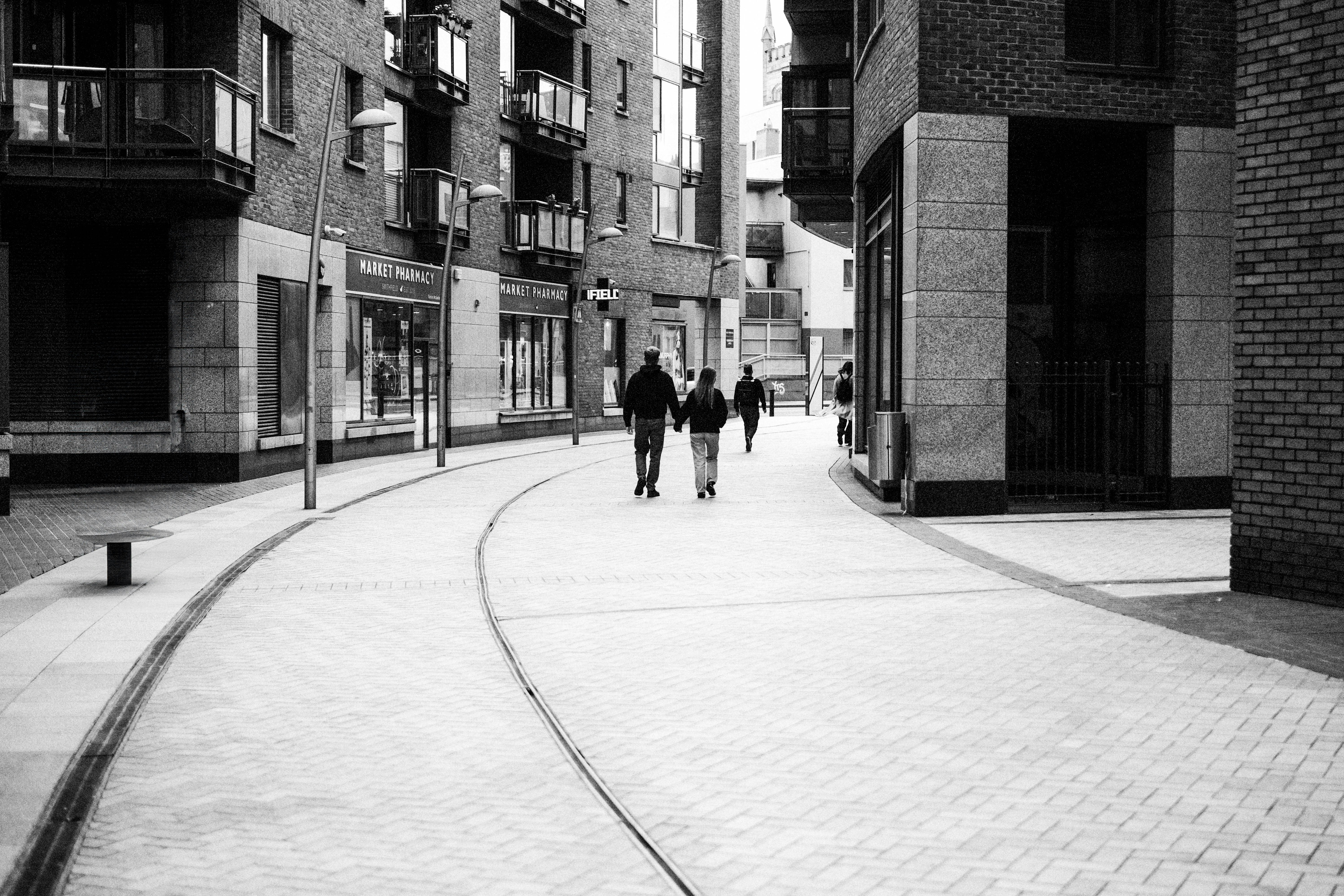 Urban Tram Tracks Converge toward a Quiet Corner