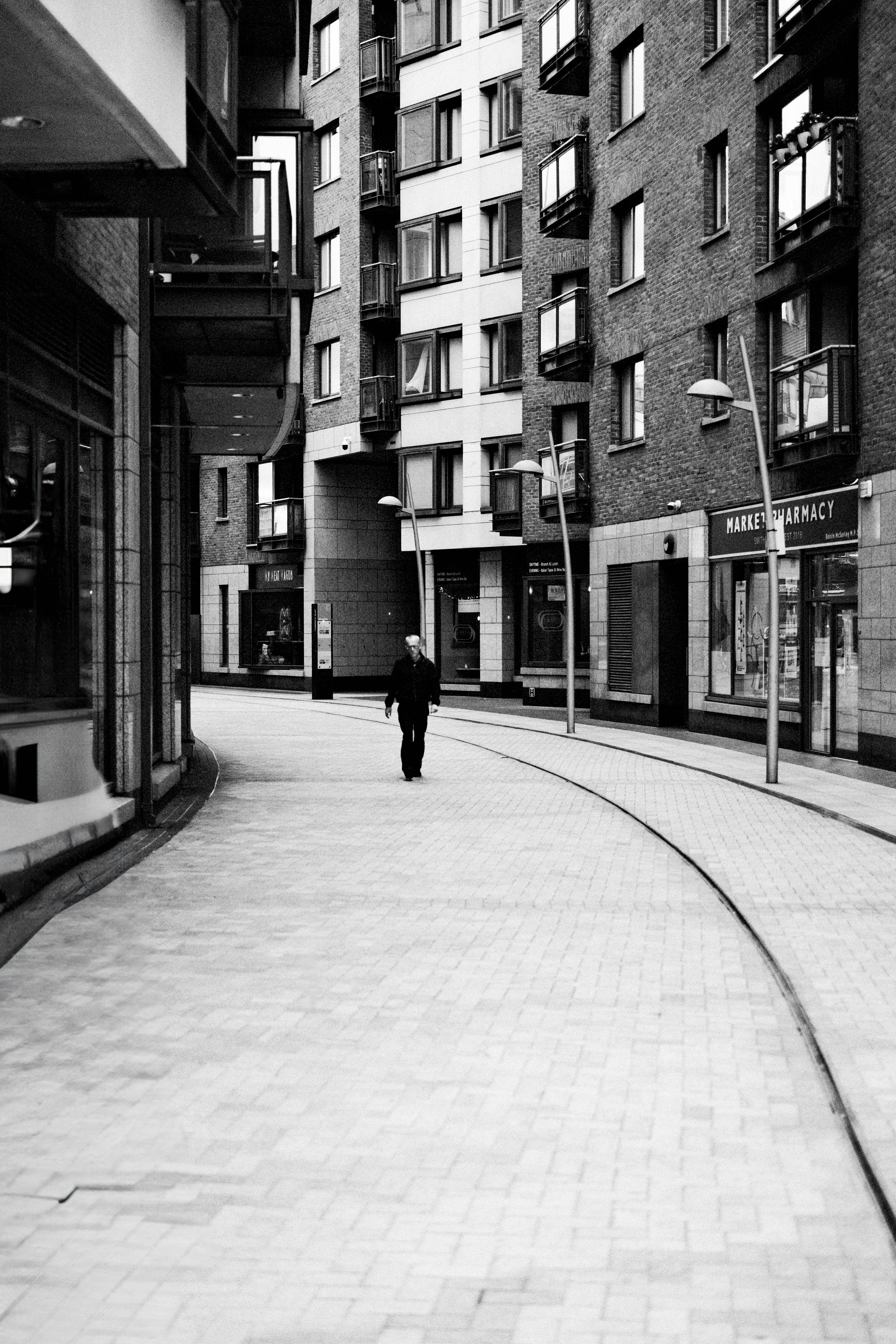 Solo Figure in a Curved City Path