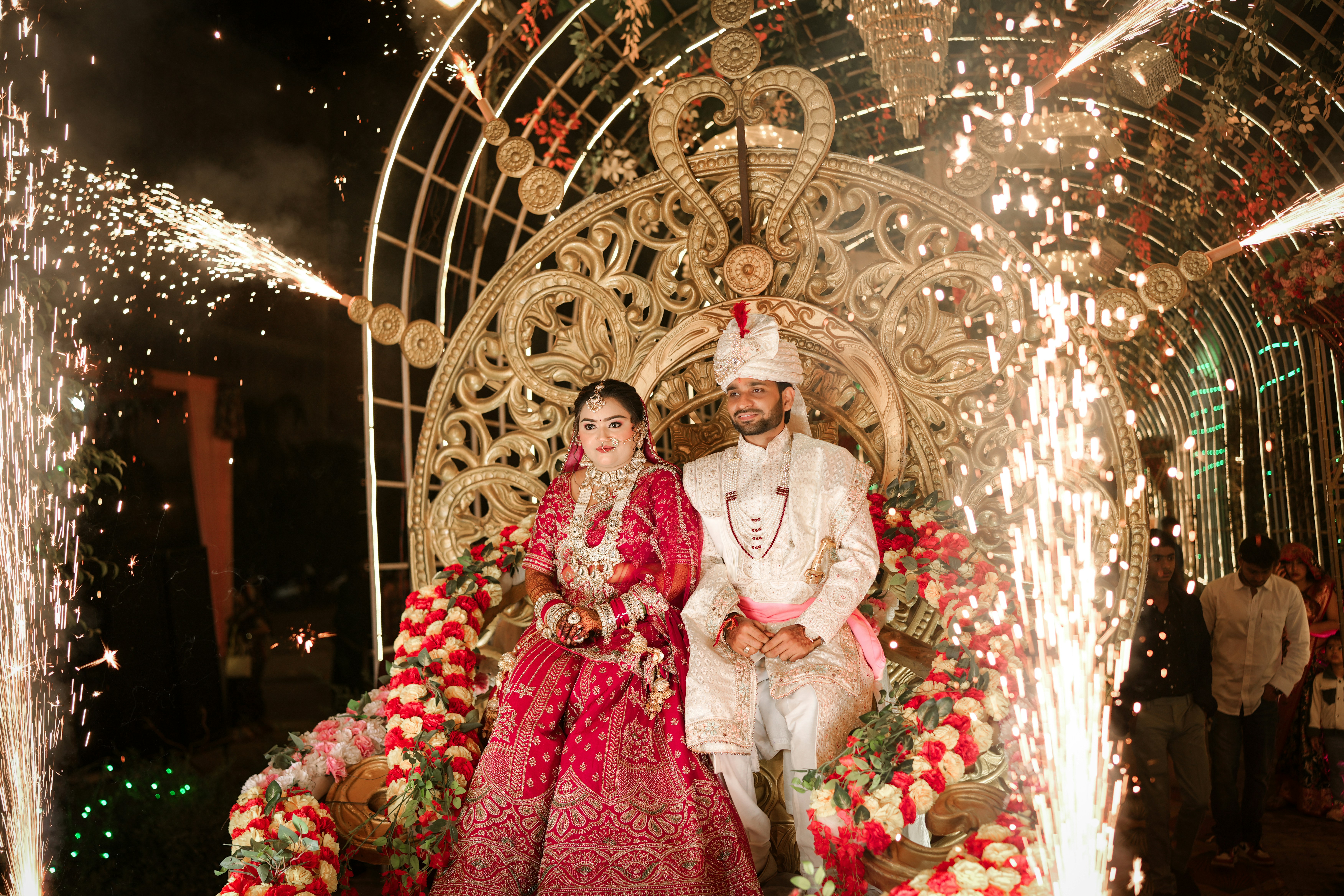 Royal Ride: A Floral Bride and Groom Amid Firework Arches