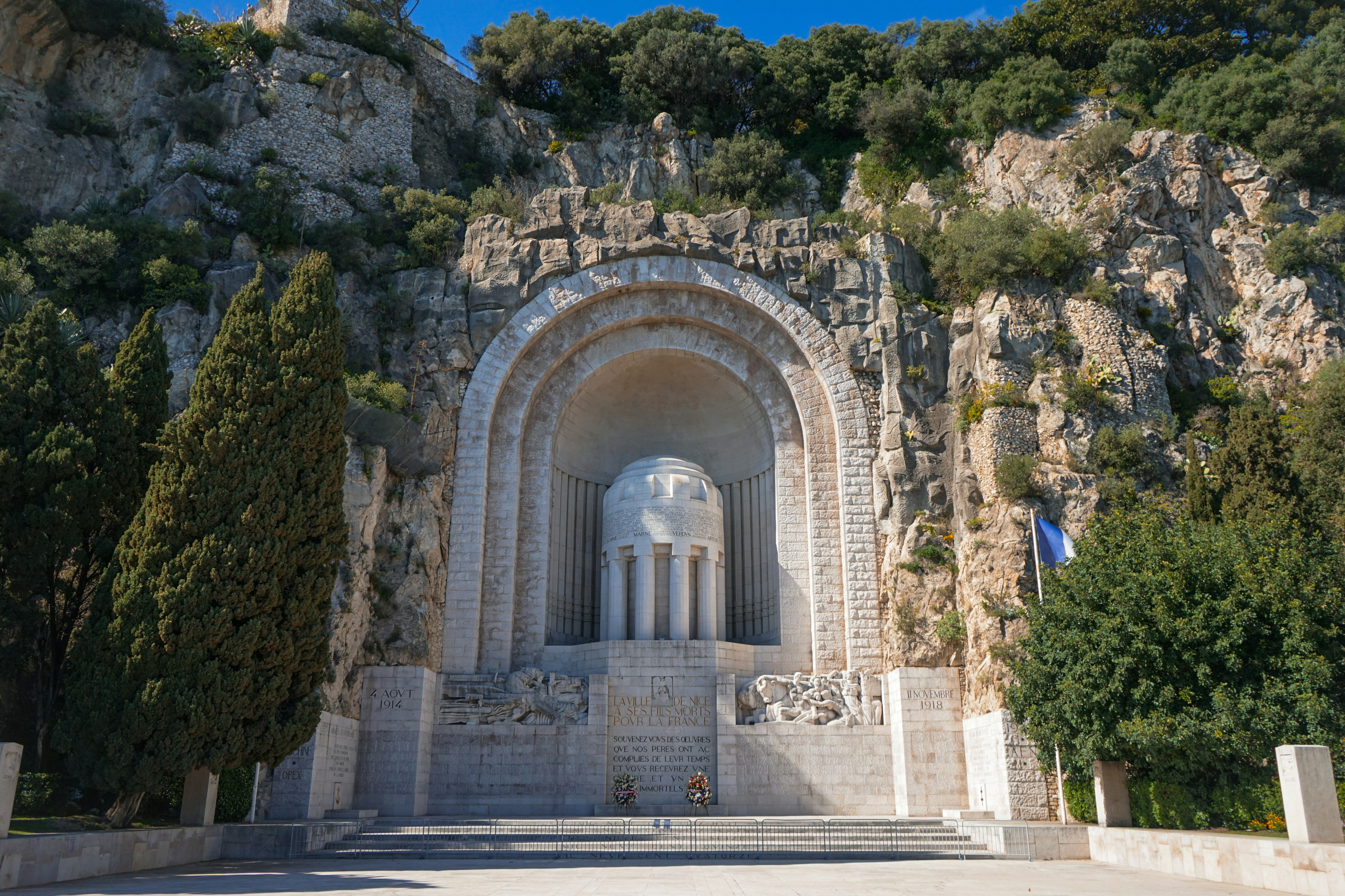Stone Archway Carved into the Mountain: A Monumental Entrance Framed by Pines