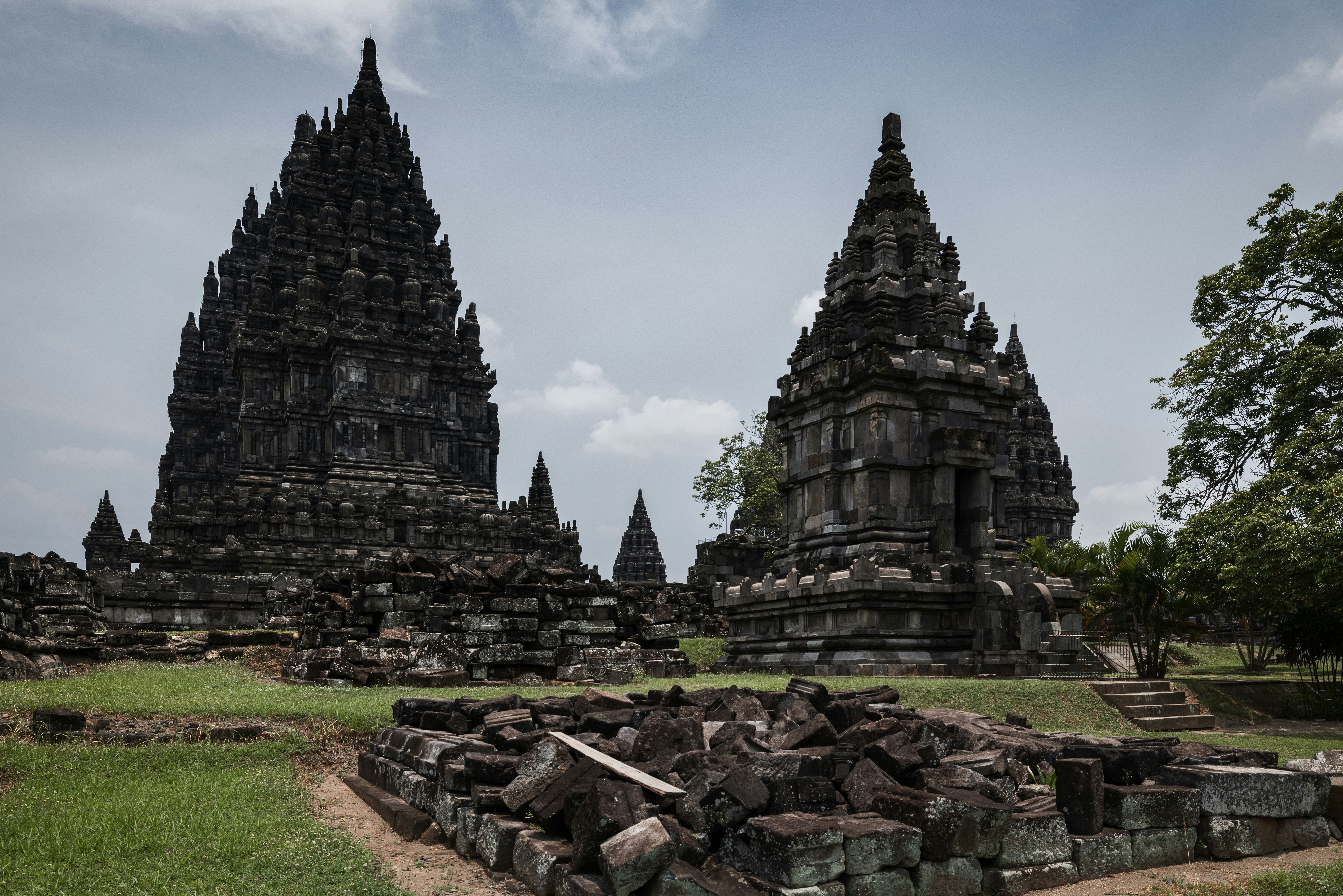 Historic stone temples with intricate spires under a cloudy sky.