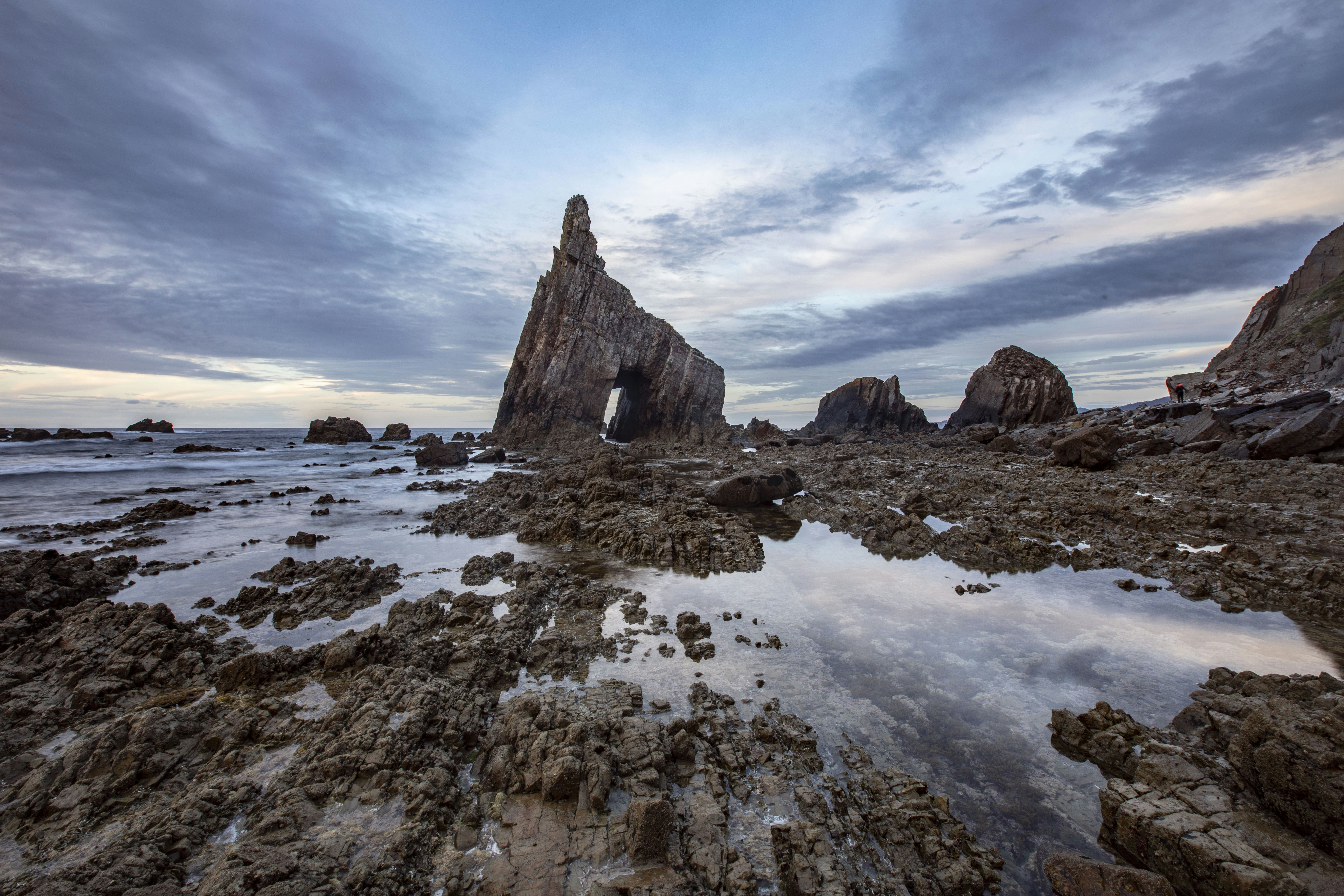 Silent Arch at Dusk: Rugged Shoreline Stepped in Stone