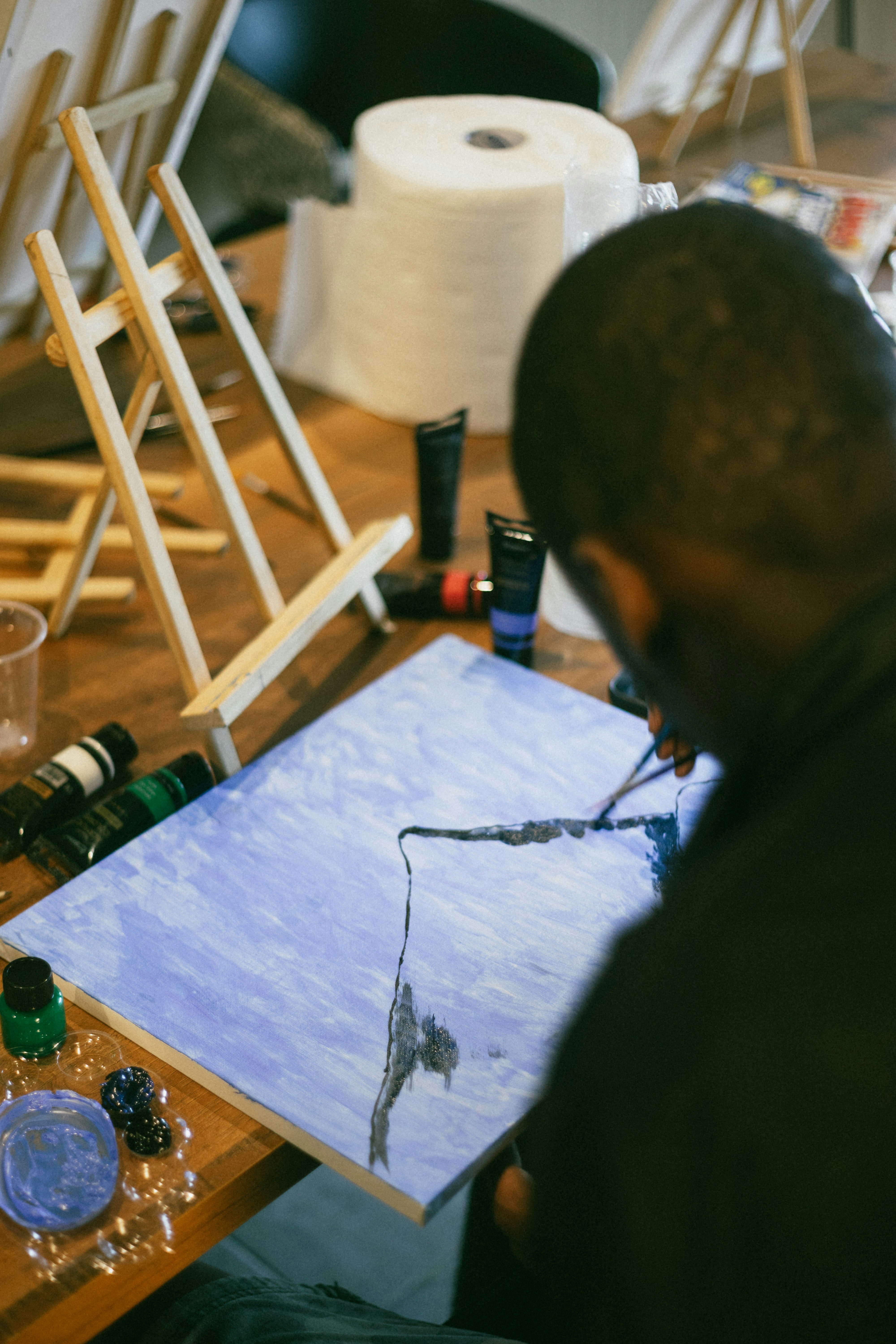 Studio Portrait of a Painter at Work on a Blue Abstract Canvas