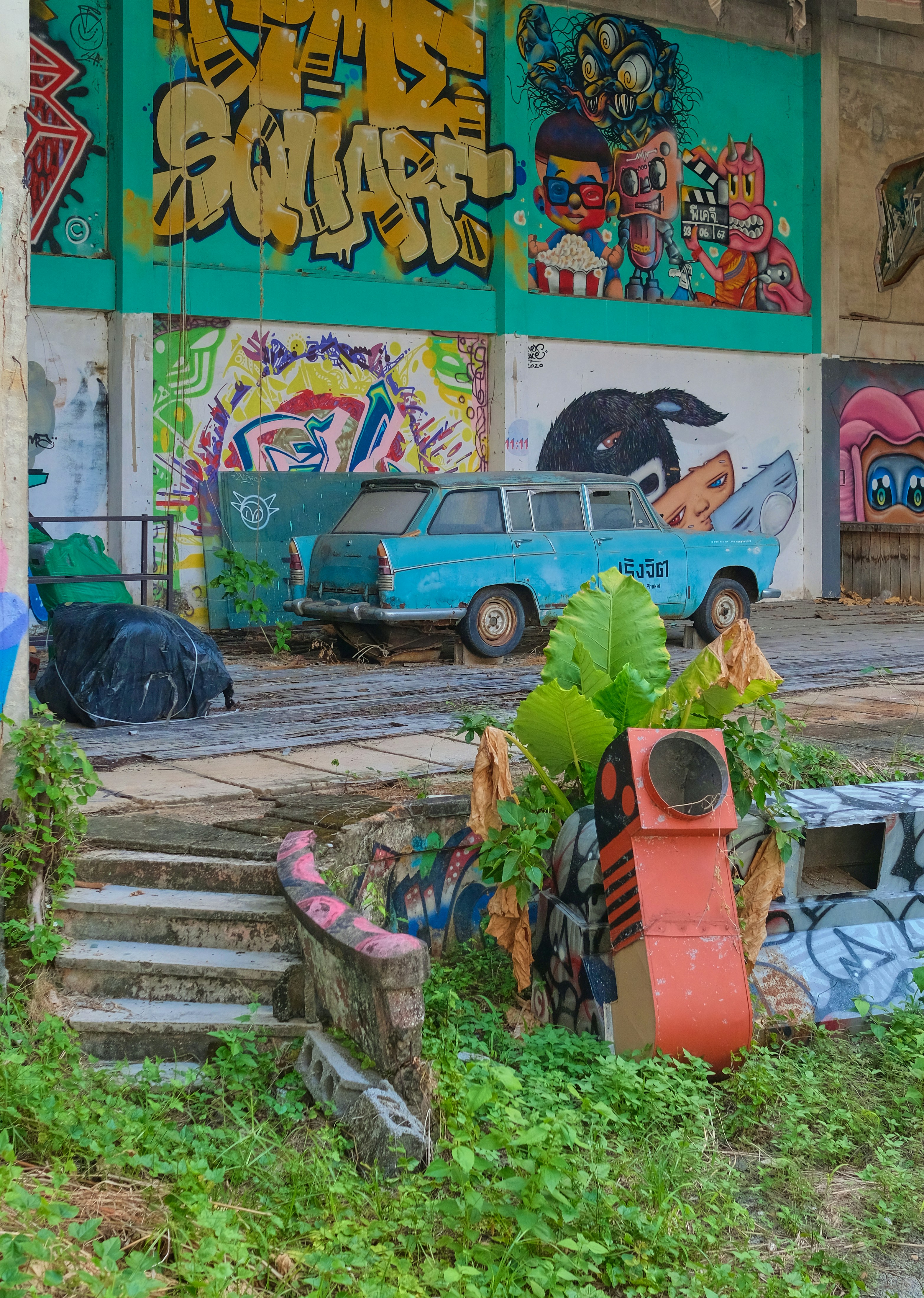 Graffiti Grove: An Abandoned Yard with a Weathered Blue Van