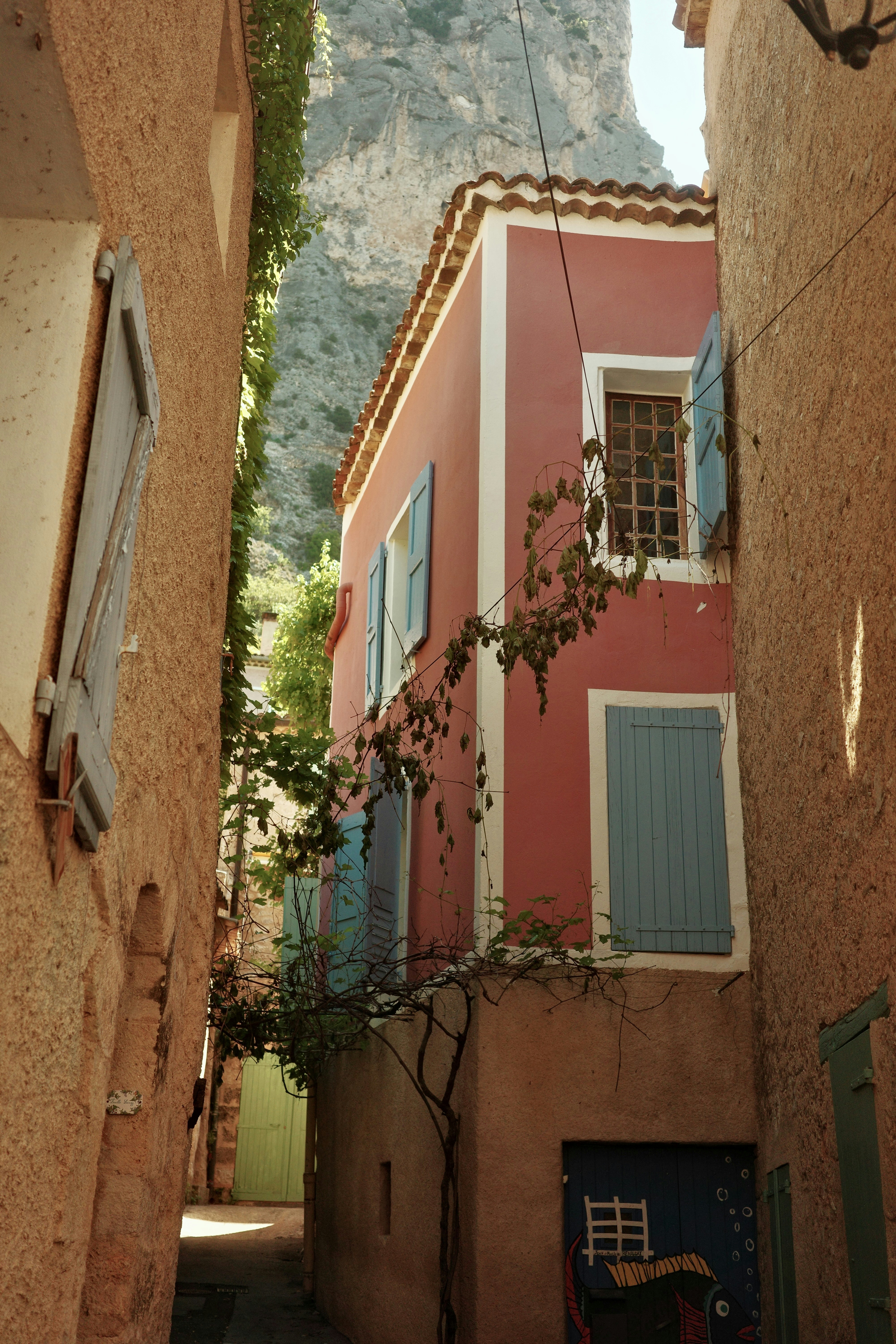 Sunlit Mediterranean Alleyway Framed by Colorful Facades
