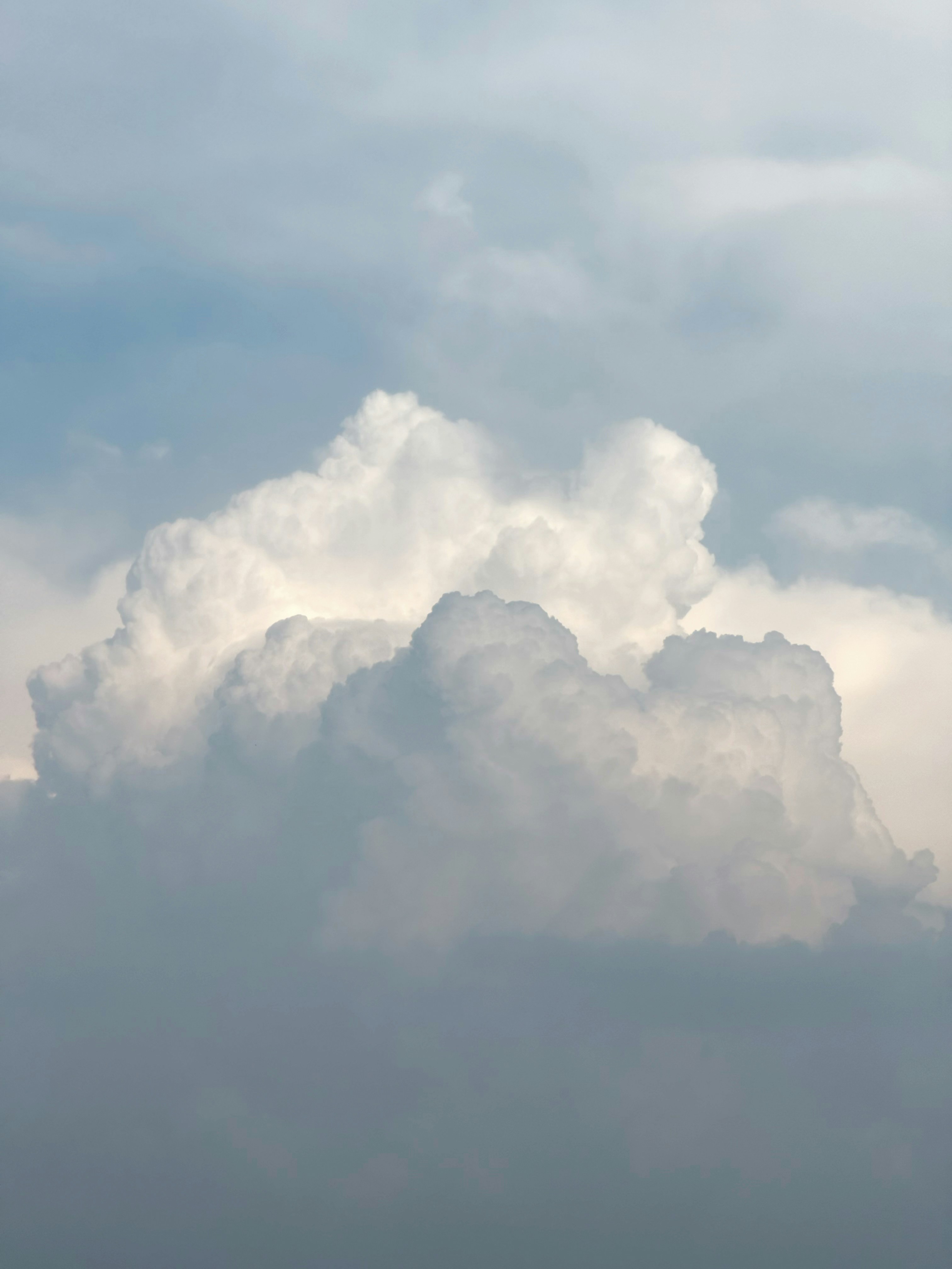 Cloud Cathedral: A Vertical Pillar of Light Above Gentle Horizons