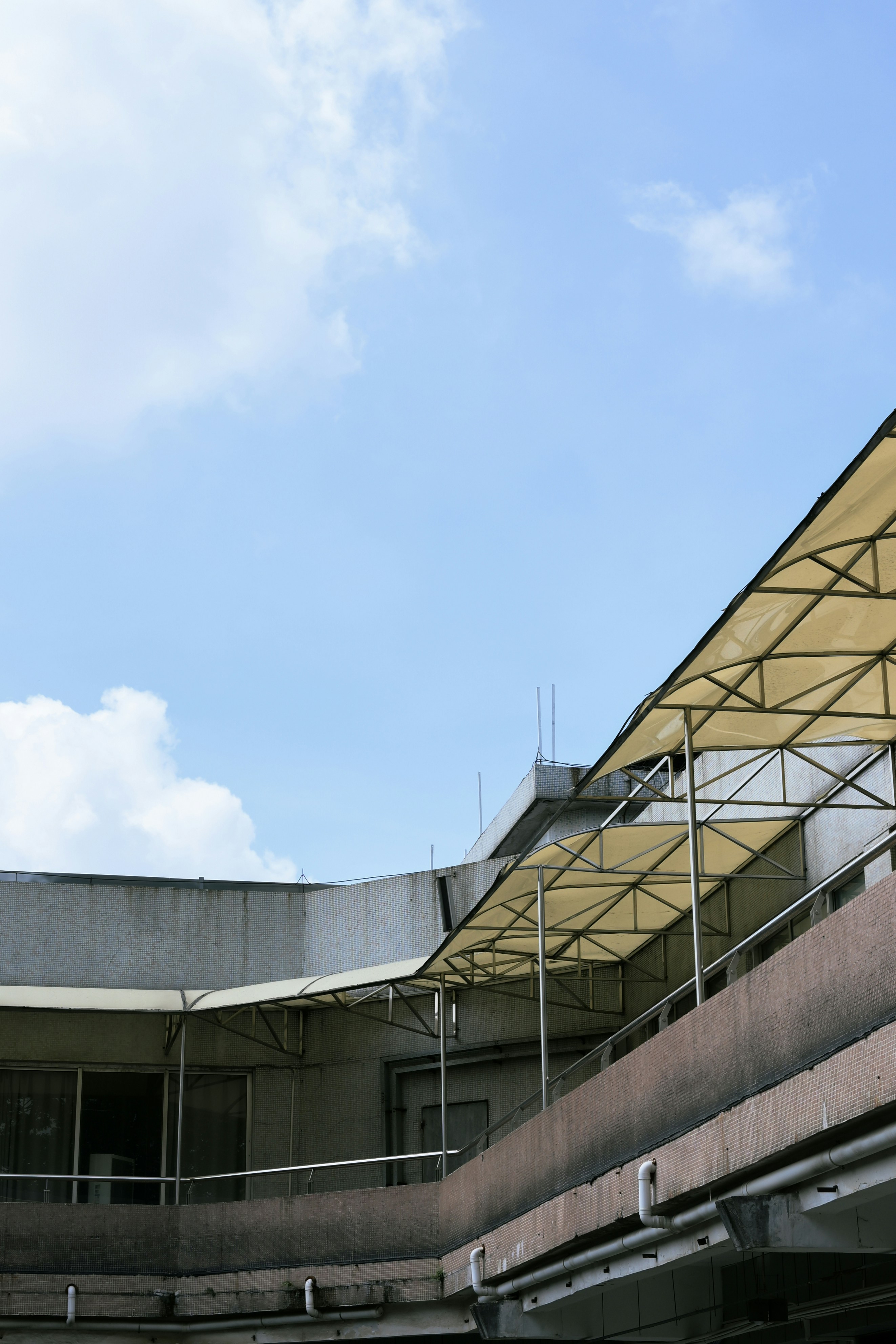 Urban Canopy: A Woven Sky Over a Brutalist Terrace