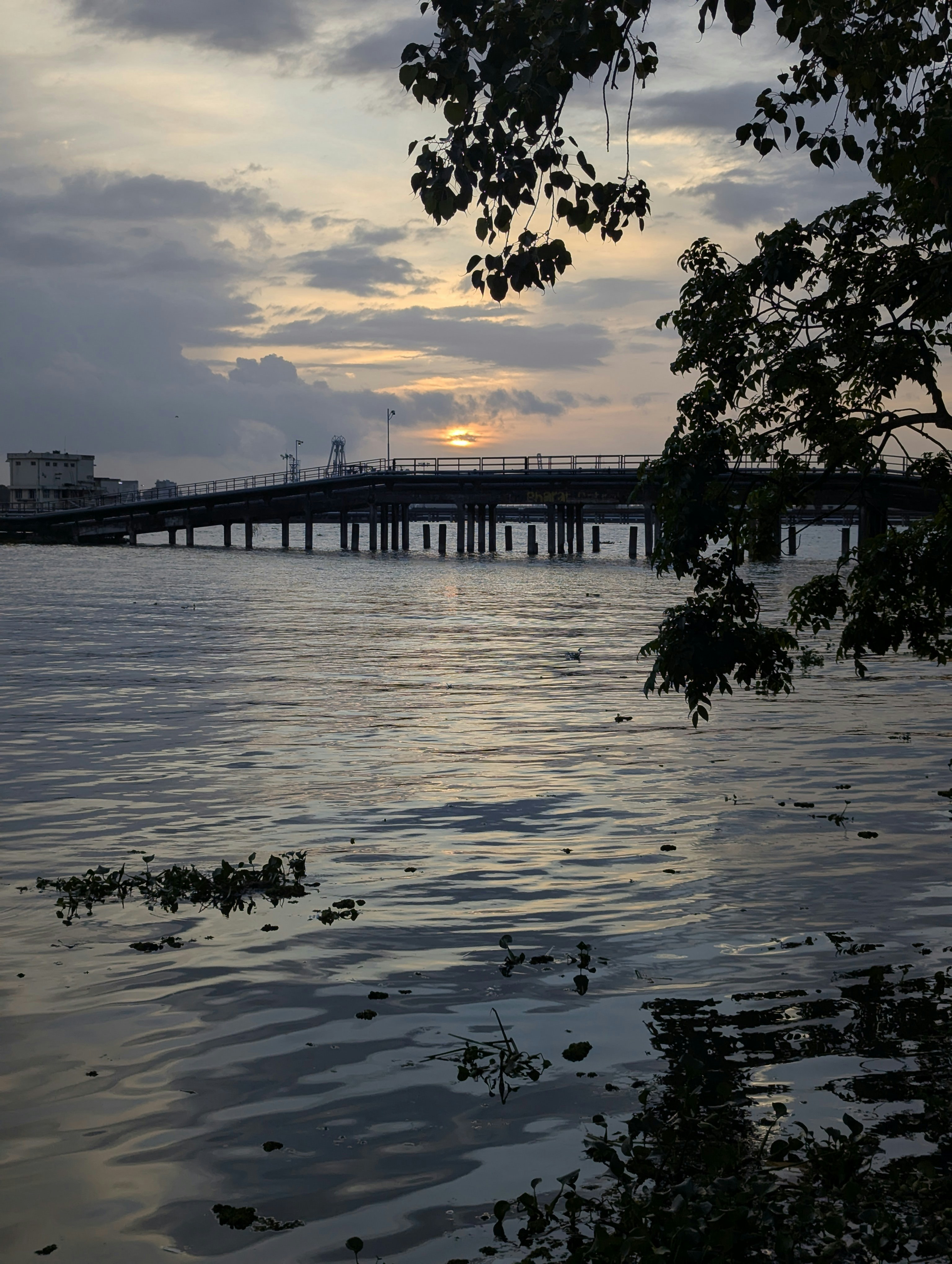 Sunset Over Riverside Pier: silhouettes and ripples