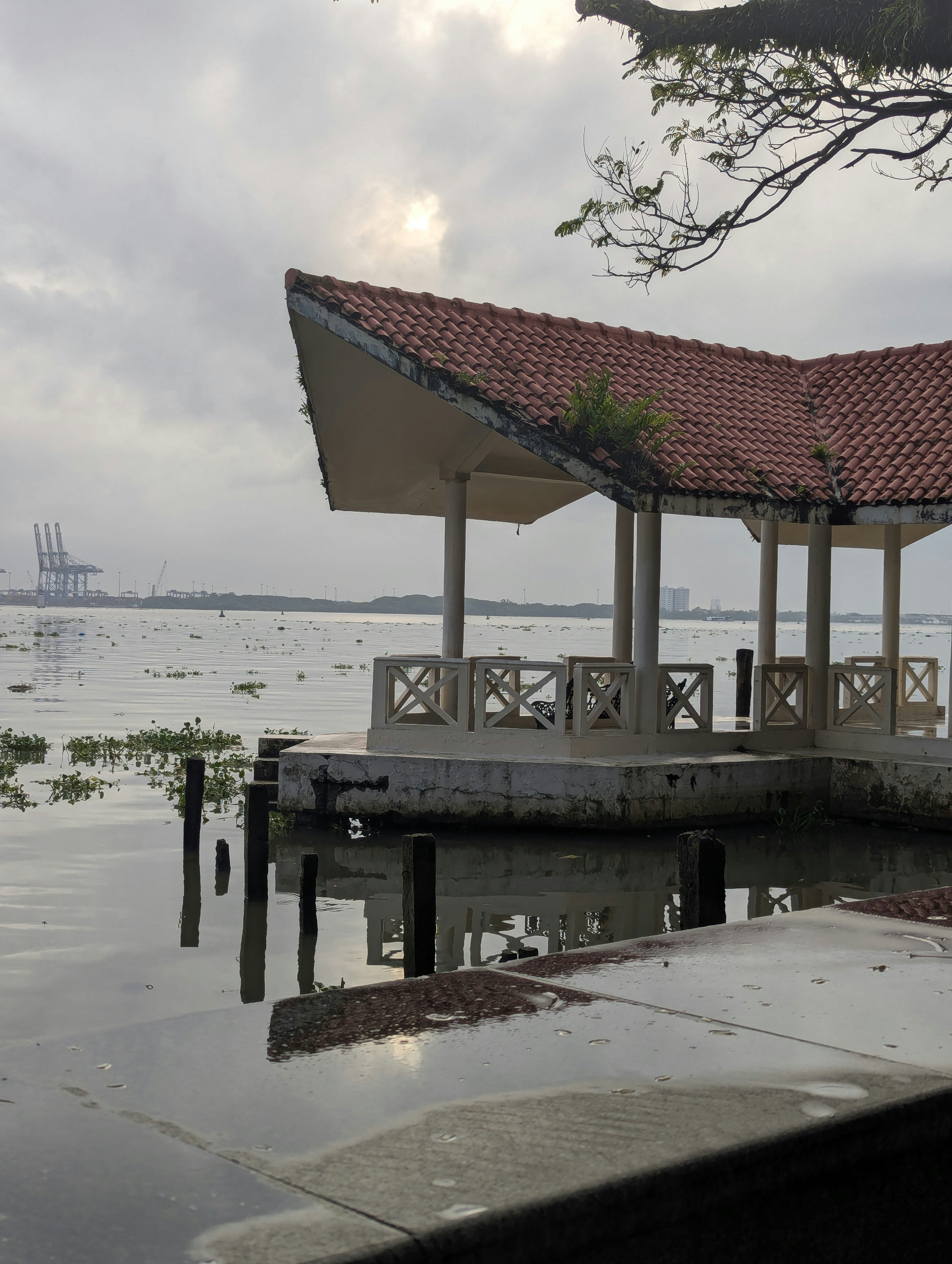 Hinged Roof Over Water: A Seaside Pavilion at Dusk