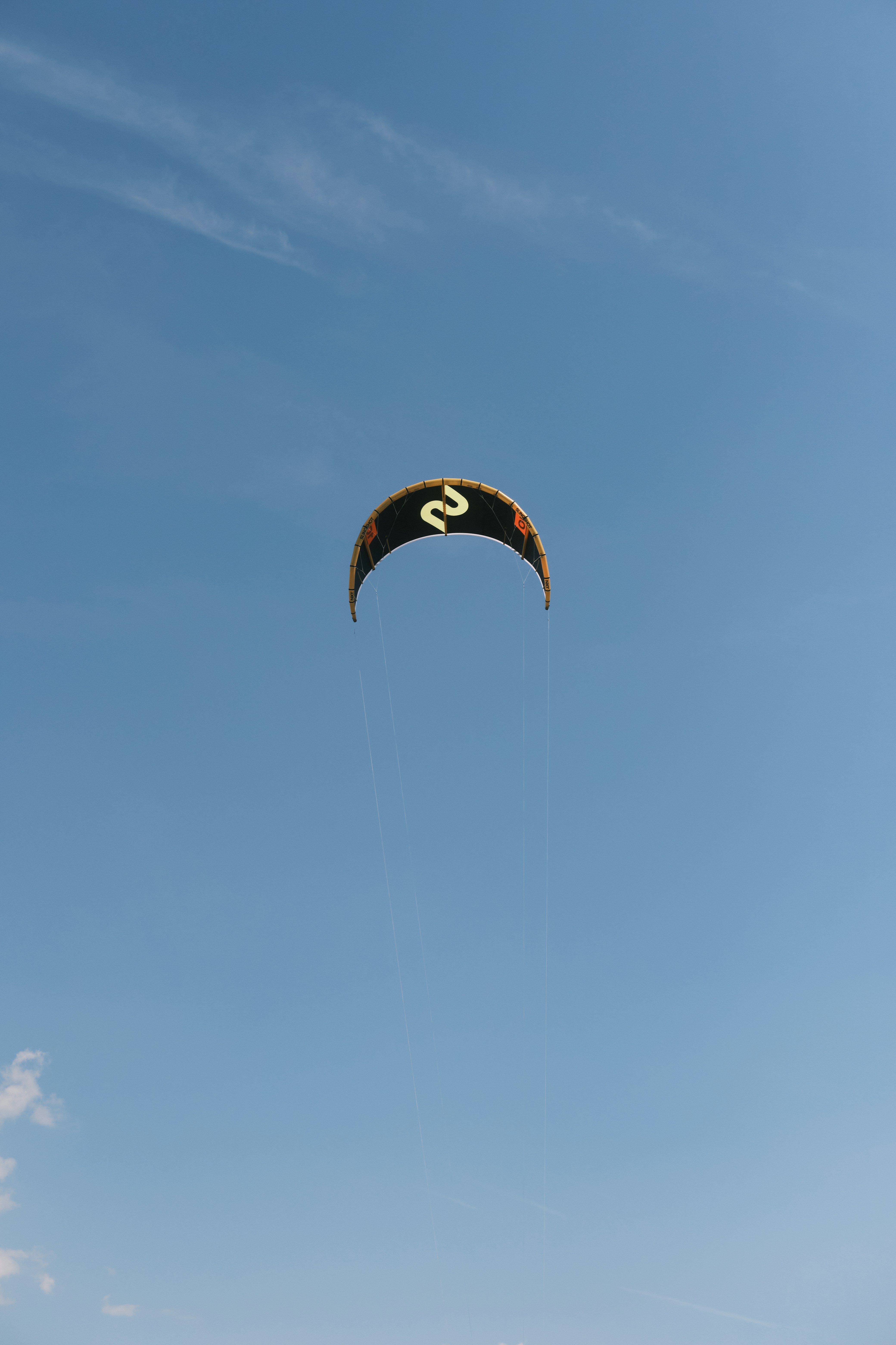 Soaring Glyph: A Single Paraglider Against a Clear Sky