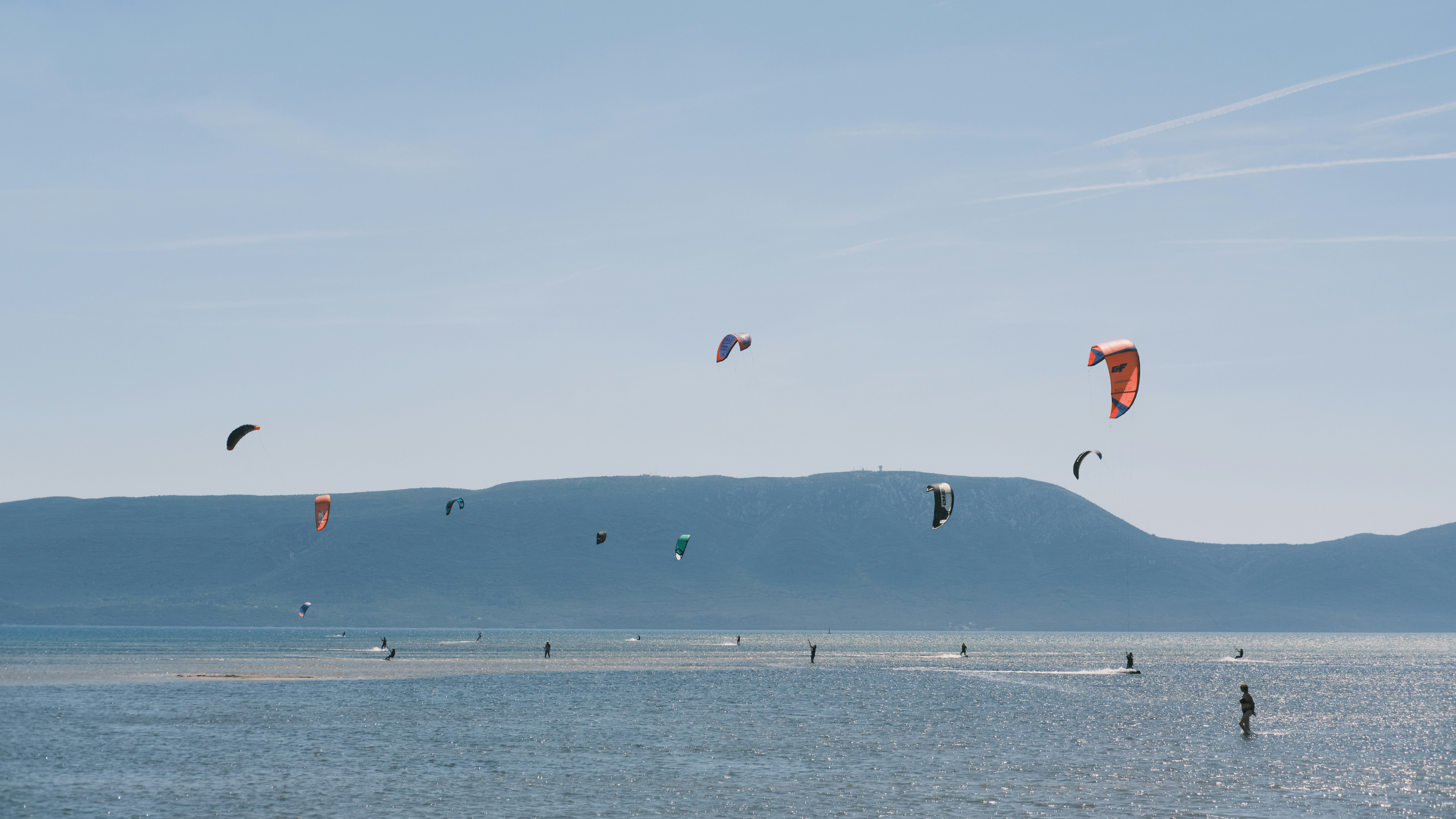 Kite Surfers Dancing Above a Calm Seascape