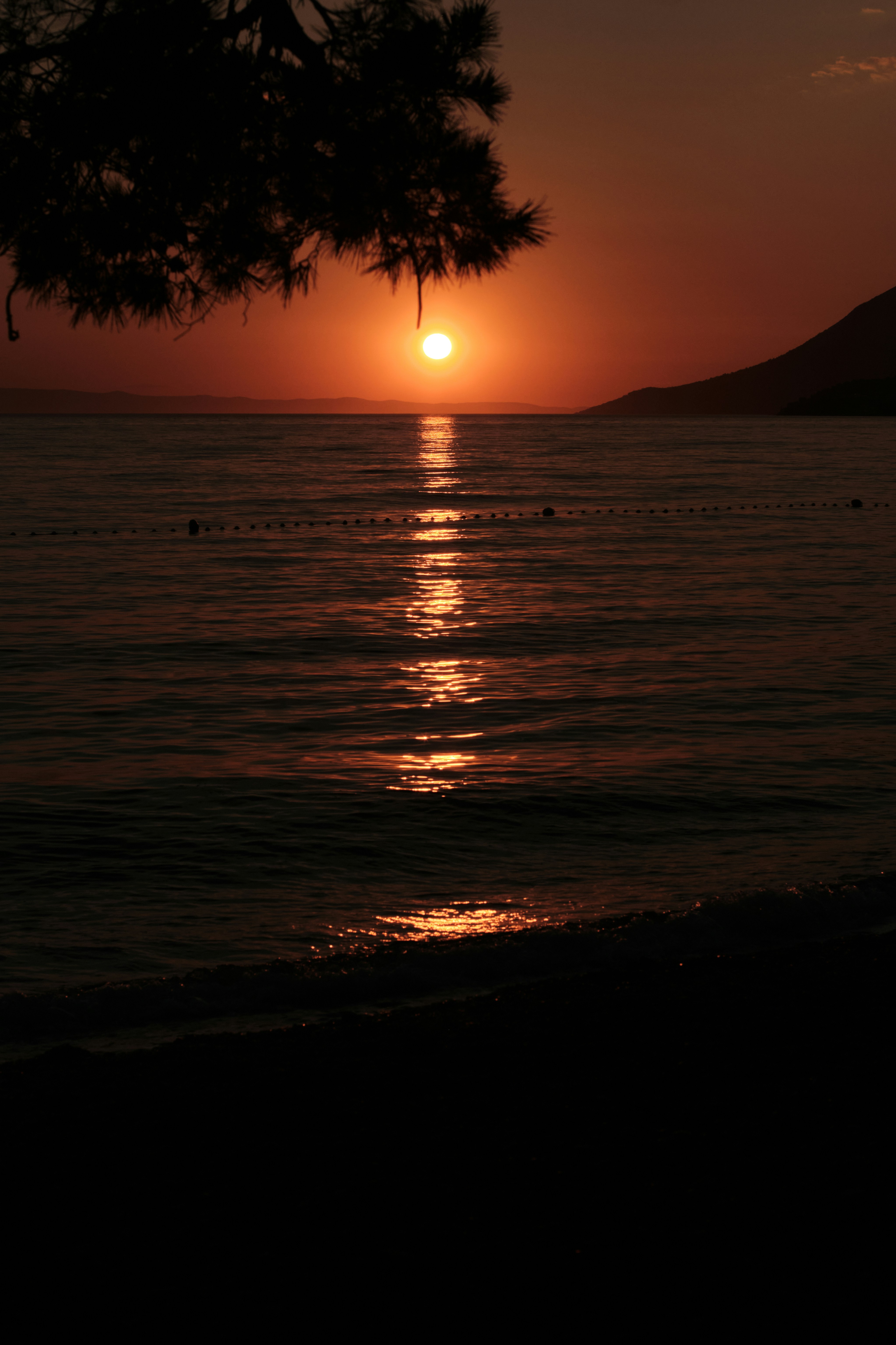 Solitary Sun Above Quiet Waters at Dusk