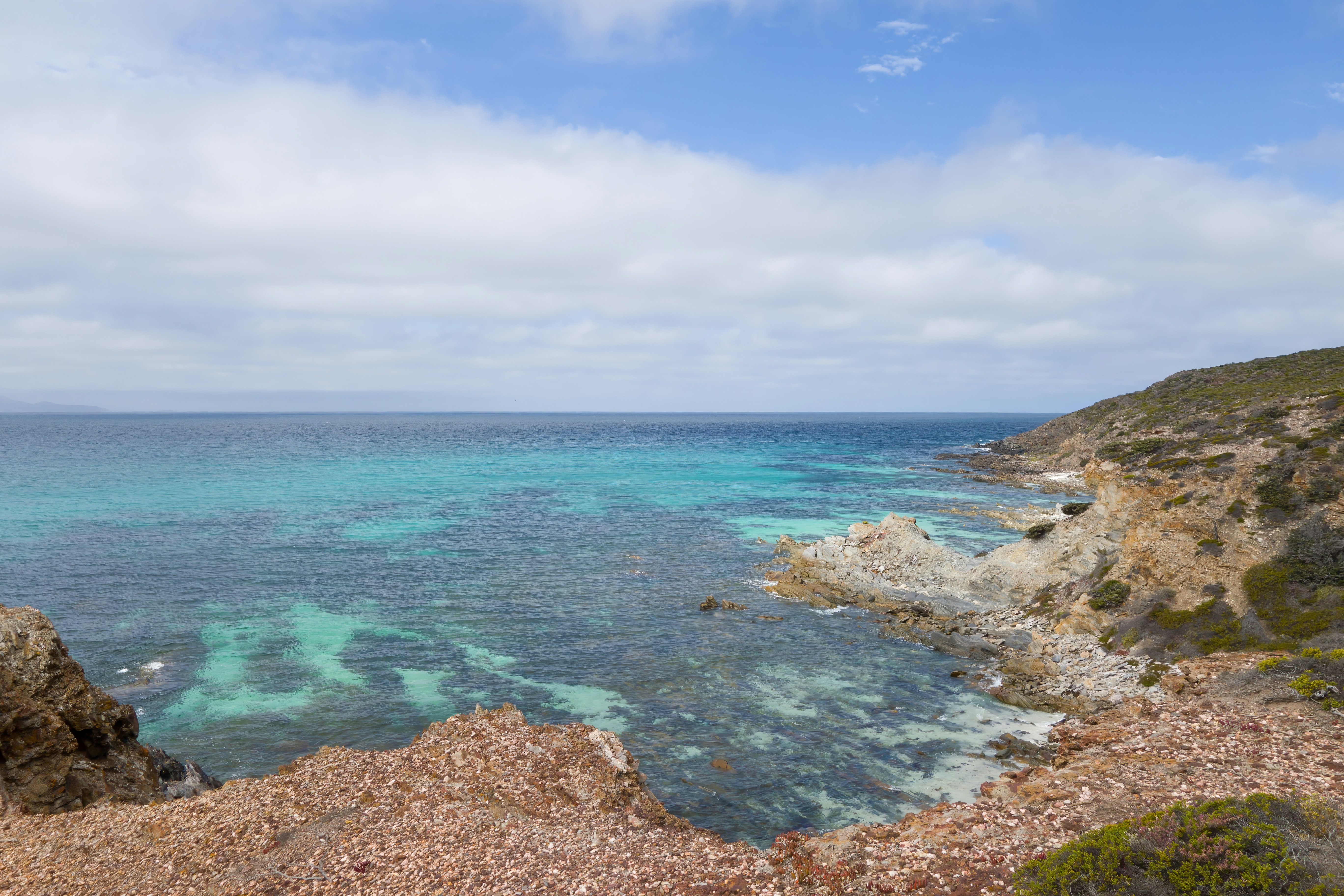 Cobalt Rim: A Seascape Where Turquoise Waters Meet Rugged Shore