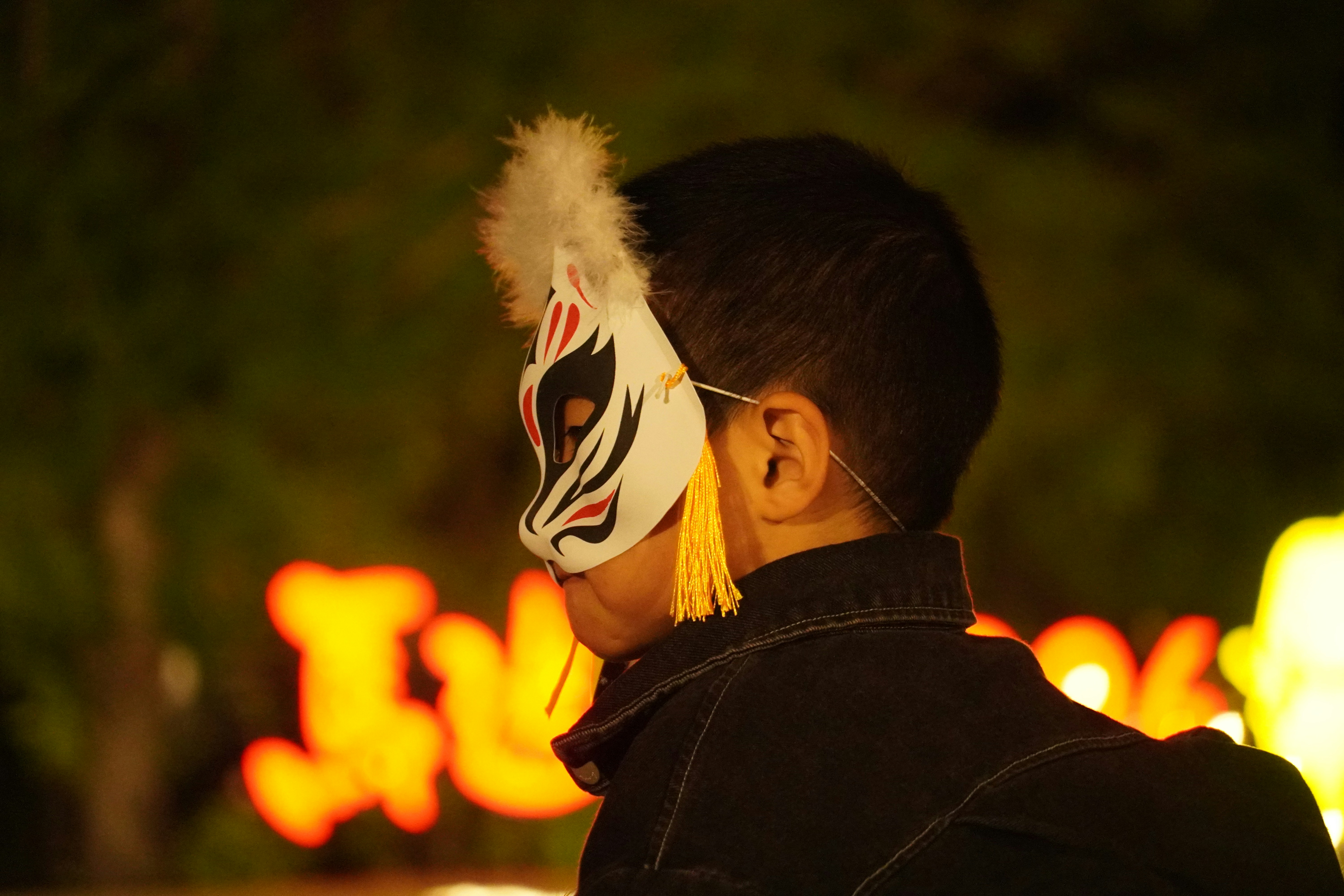 Masked Muse at Dusk: A Backlit Portrait with Neon Bokeh
