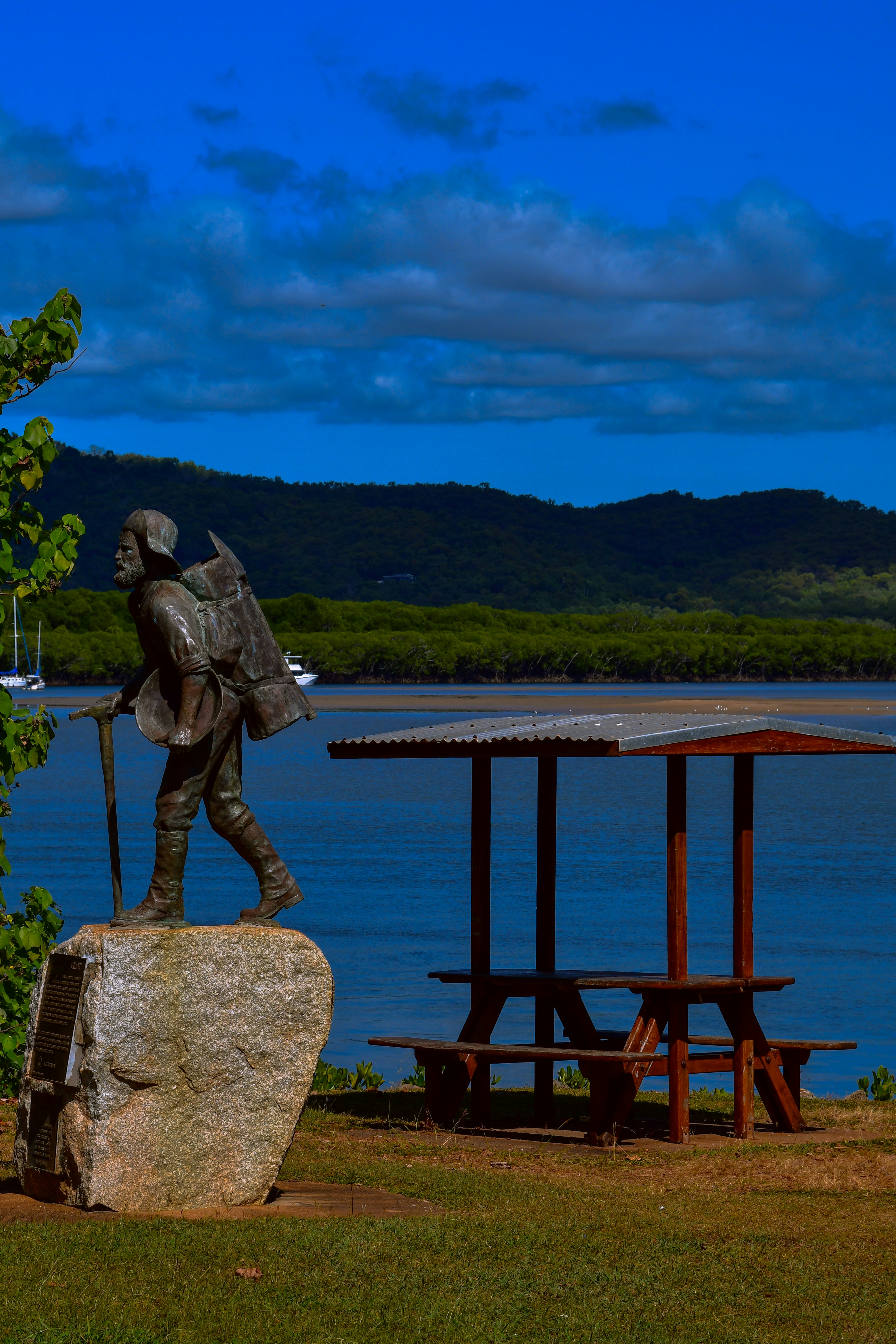 Statue Adventurer by the Lake: A Quiet Shoreline Portrait