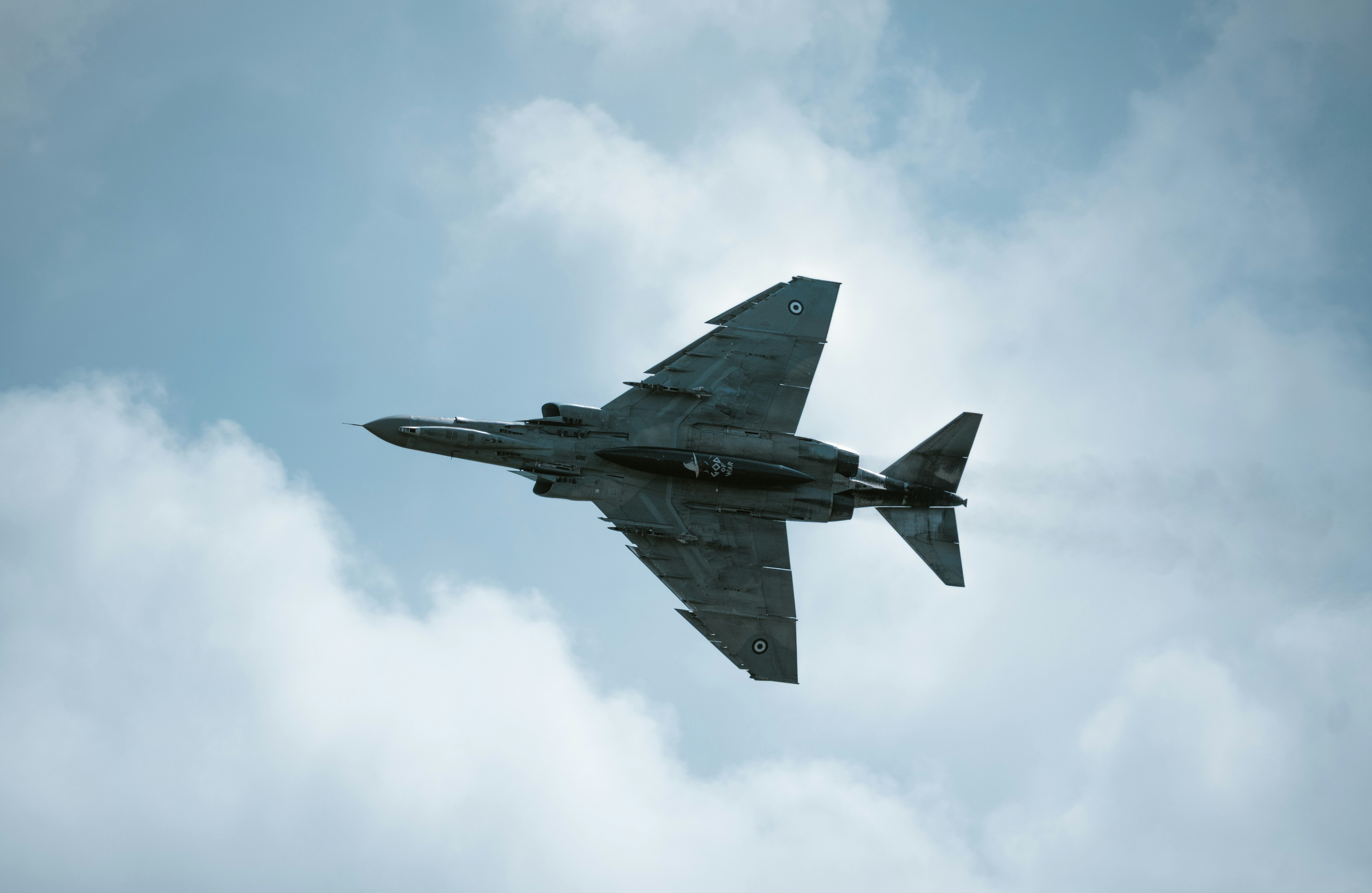 Mid-Flight Shadow: A Dark Jet Silhouette Against the Clouds