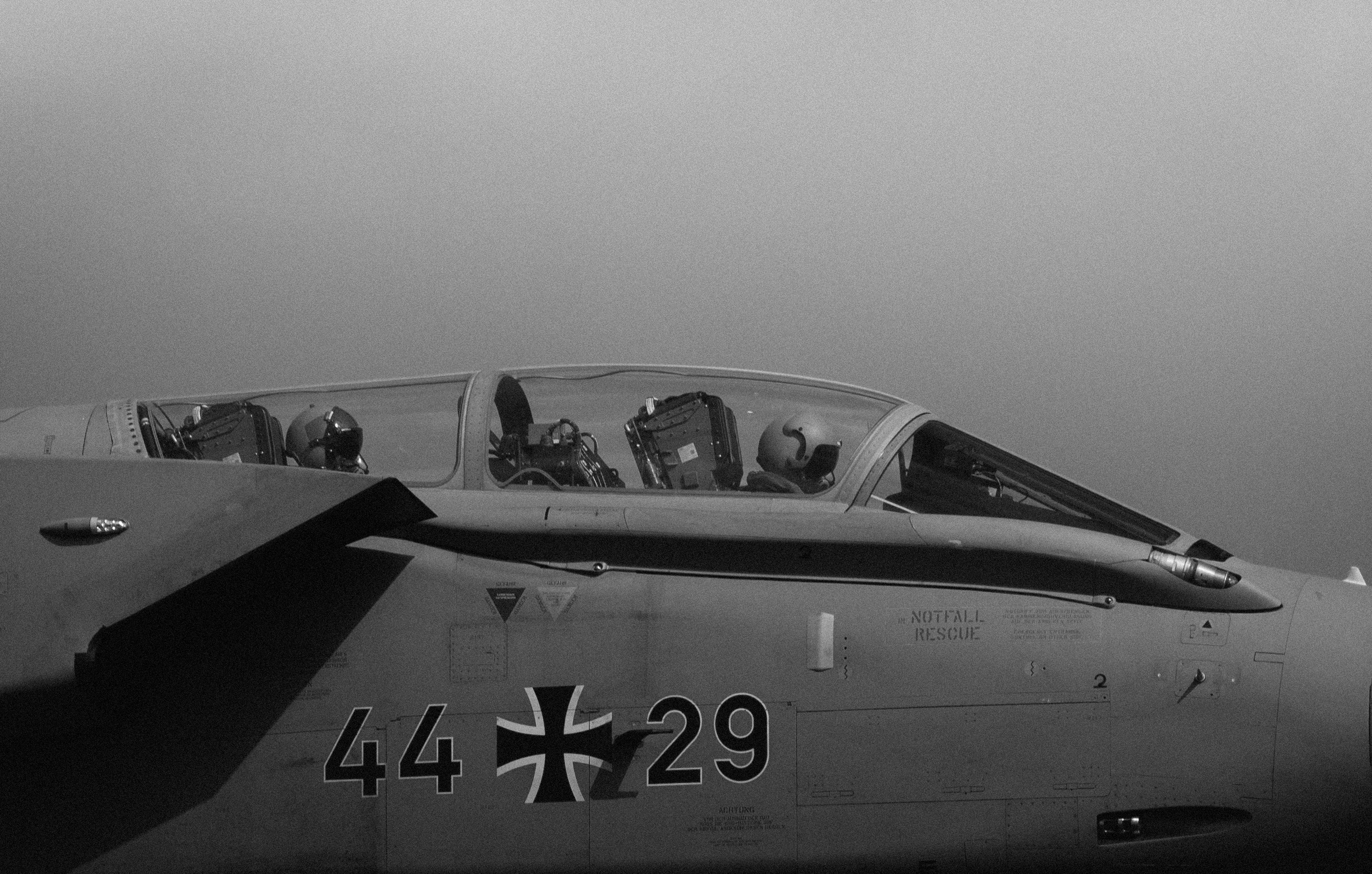 German military jet with two pilots in the cockpit.