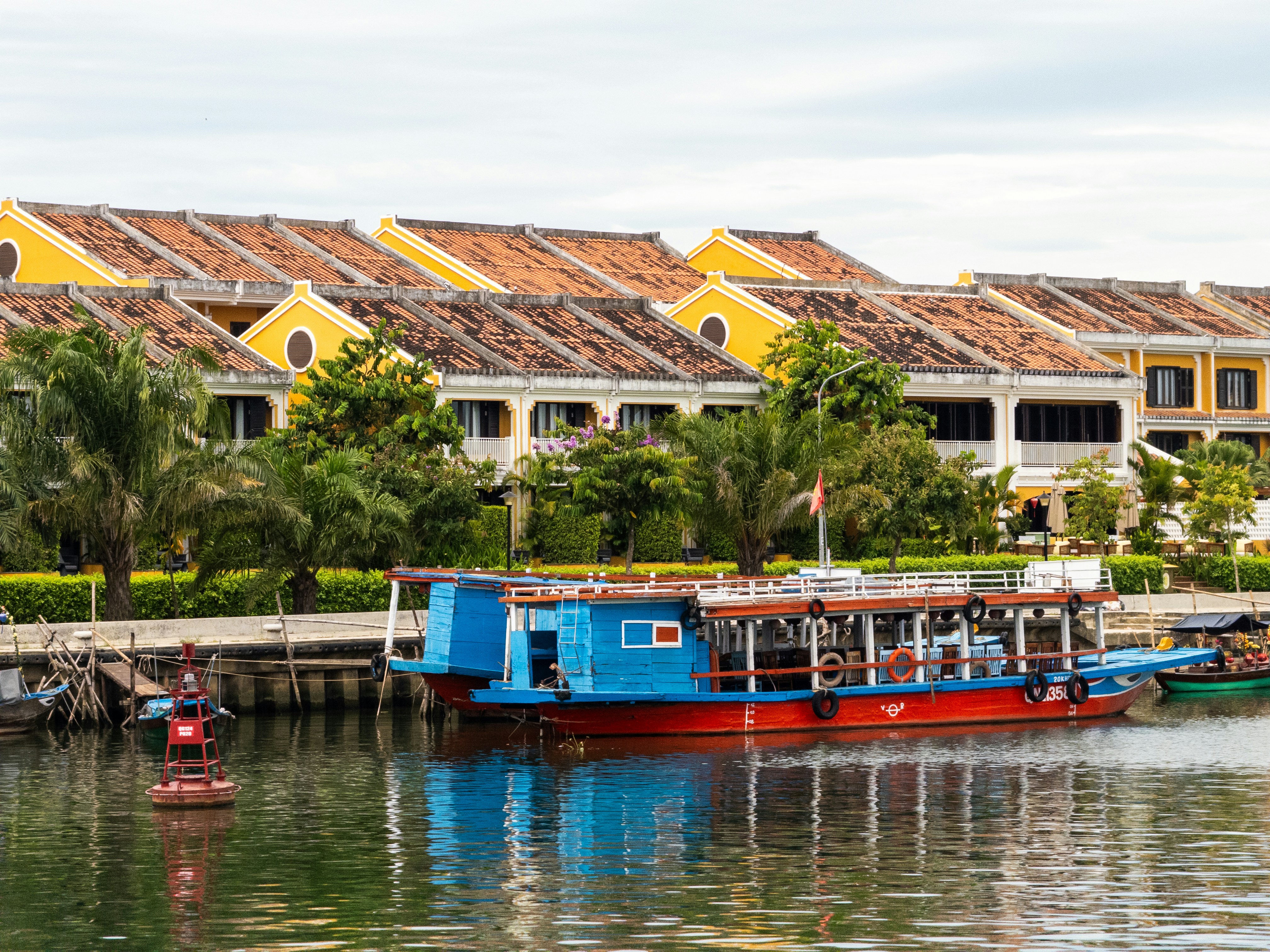 Colorful Waterfront Whimsy with a Bright-Striped Boat