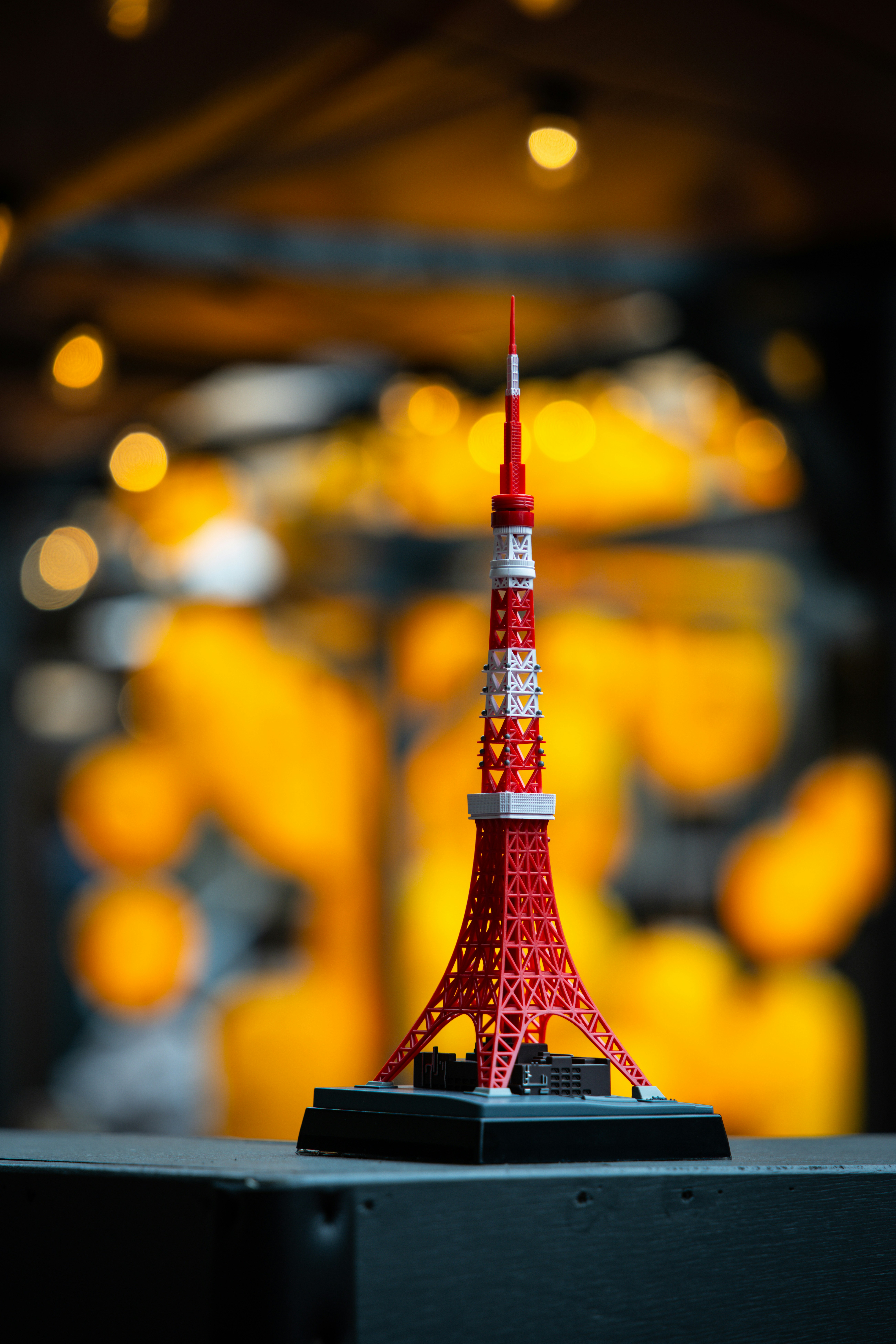 Mini Tokyo Tower on a Darkened Stage of Warm Lights