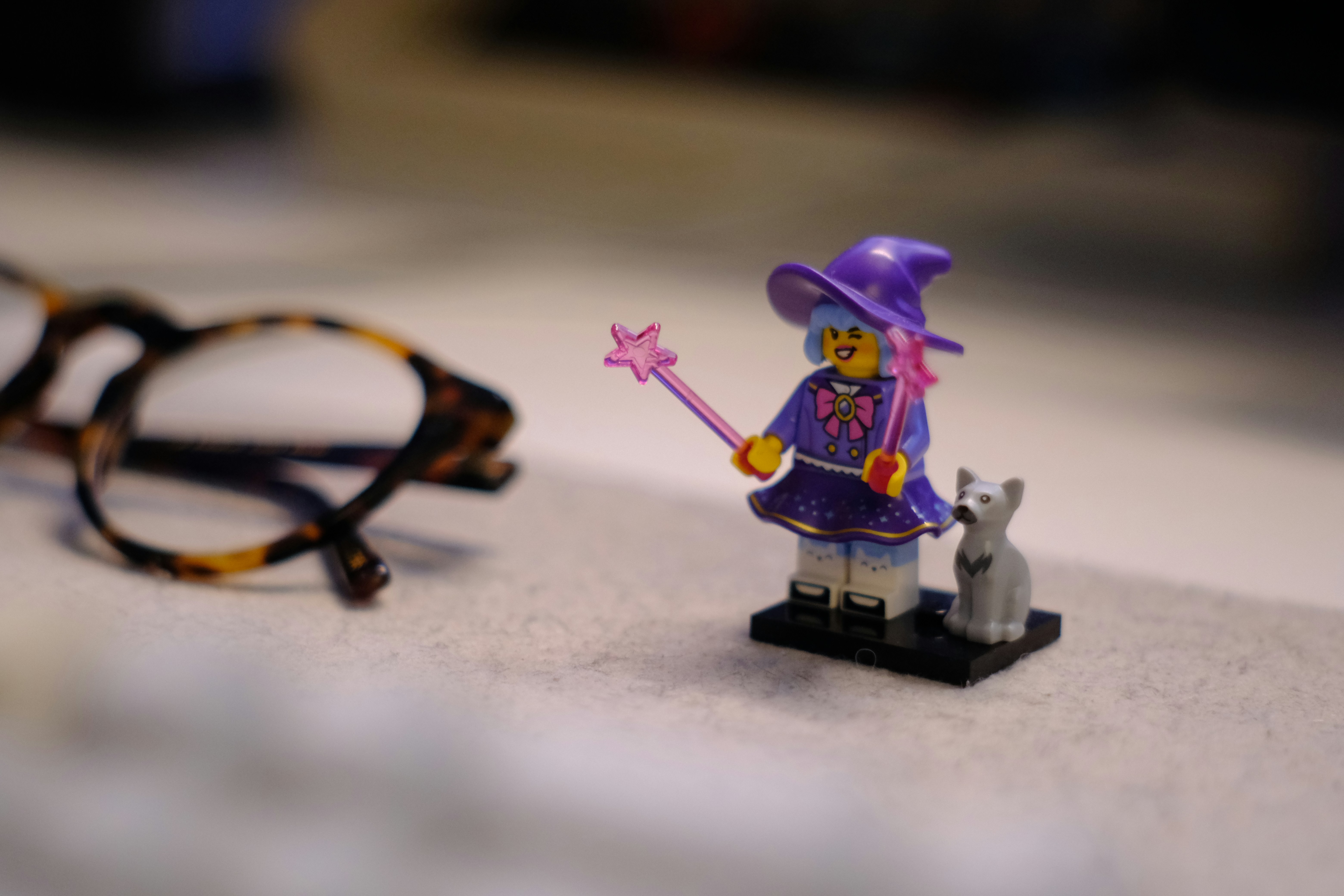 Miniature Witch with Star Wand: A Playful Scene in Soft Focus