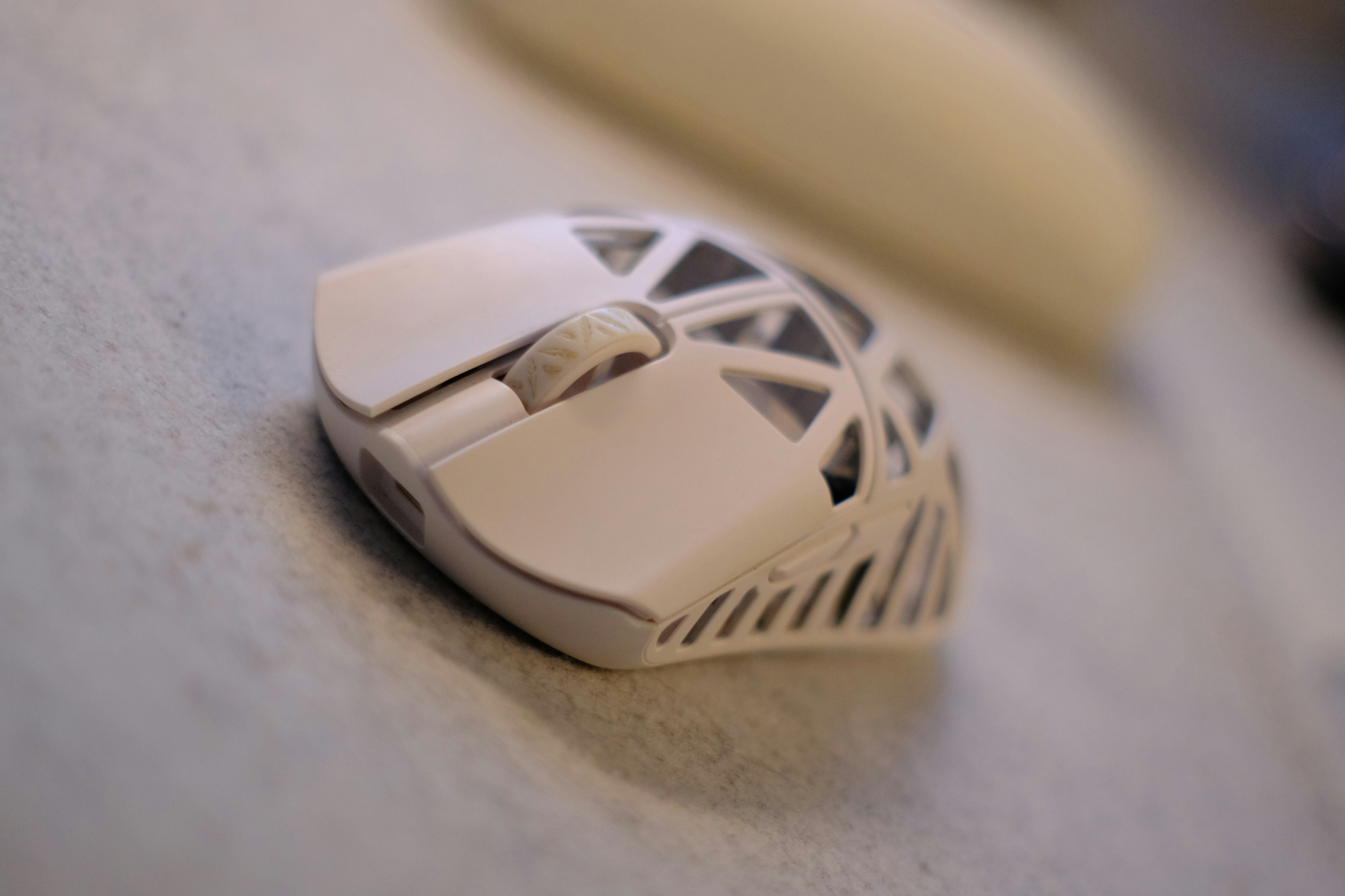 A white computer mouse with a geometric shell design.