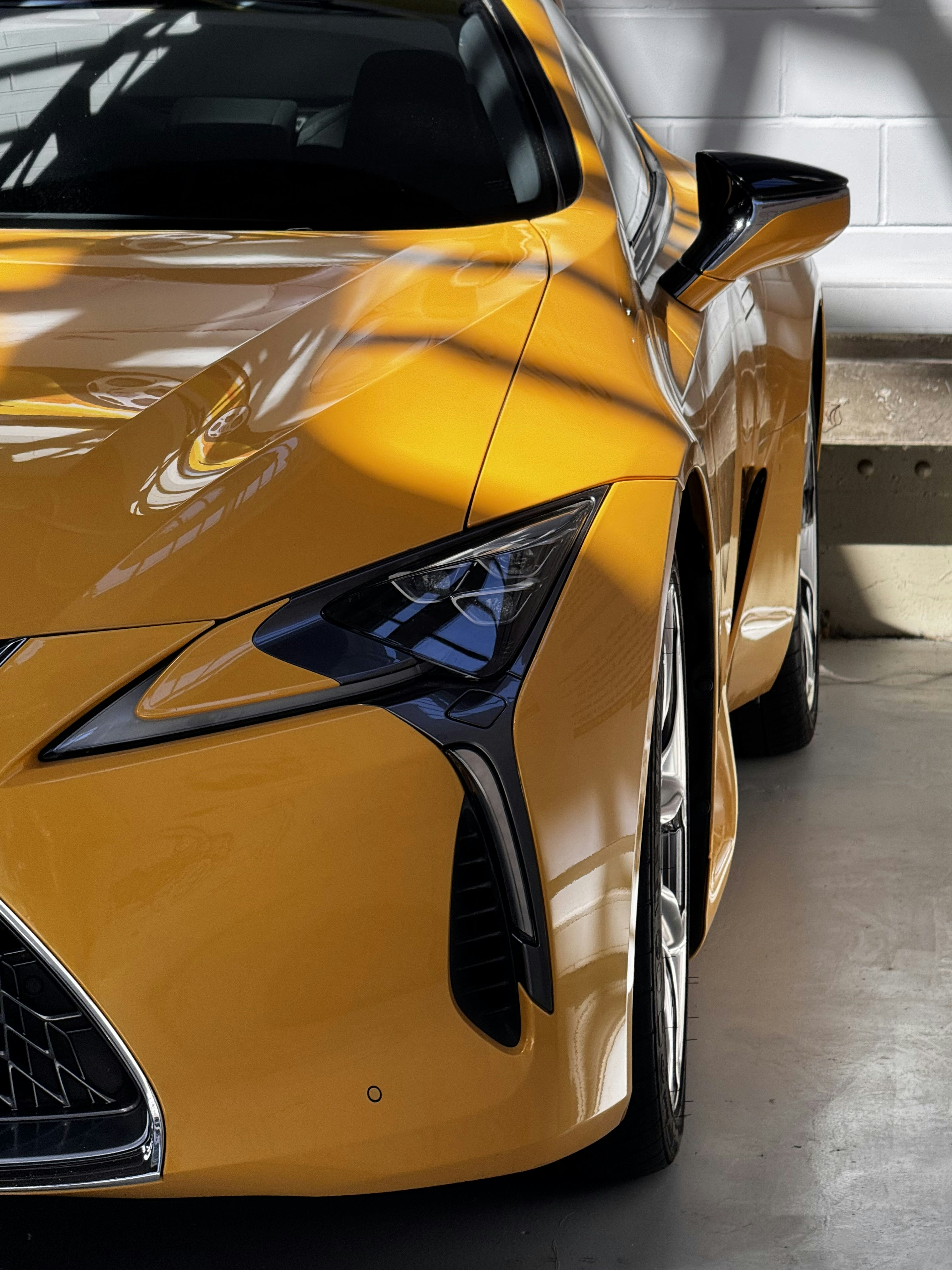 Golden Arc: The Front Quarter of a Bright Sports Car