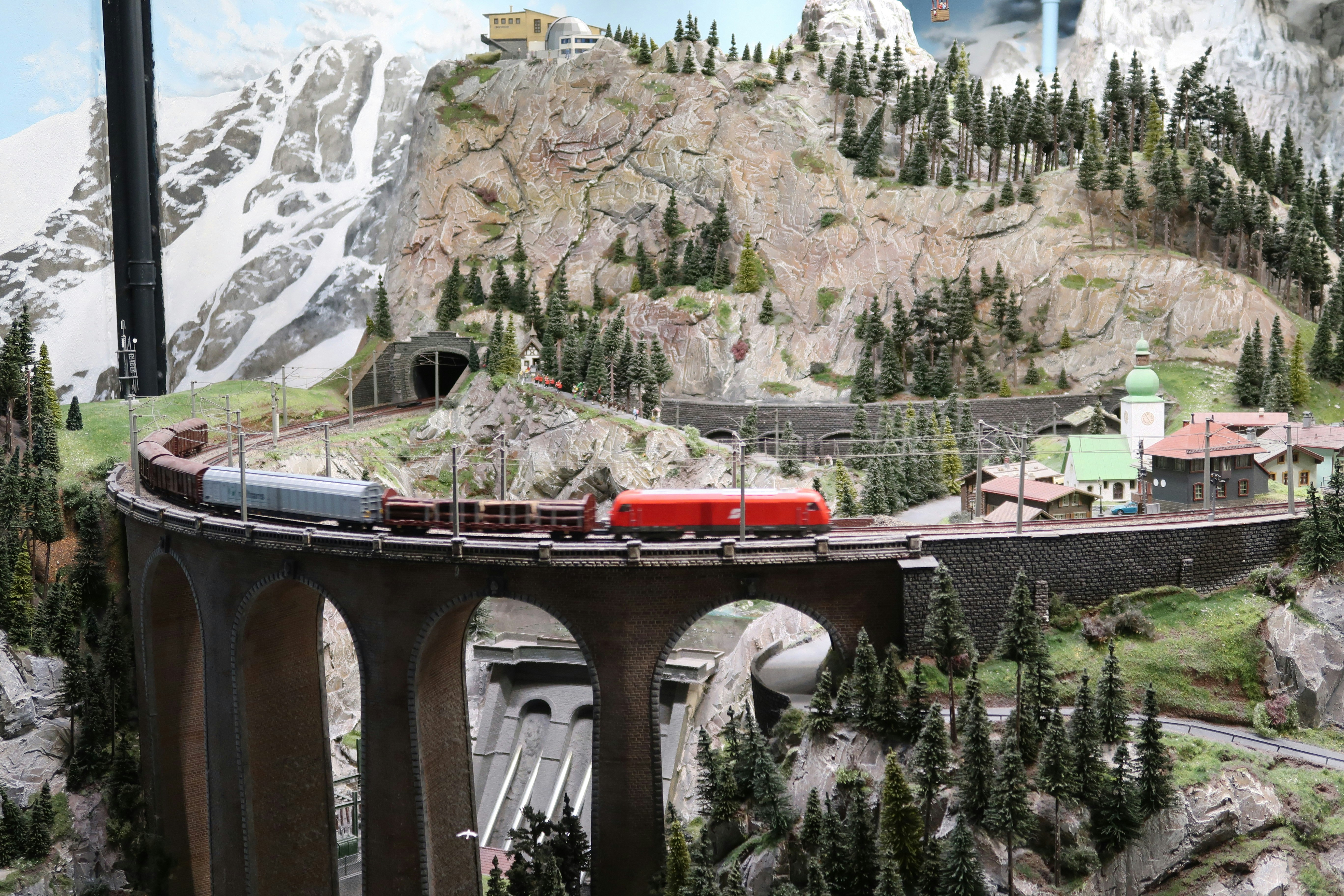 Model Train on a Viaduct: A Miniature Alpine Landscape in Motion
