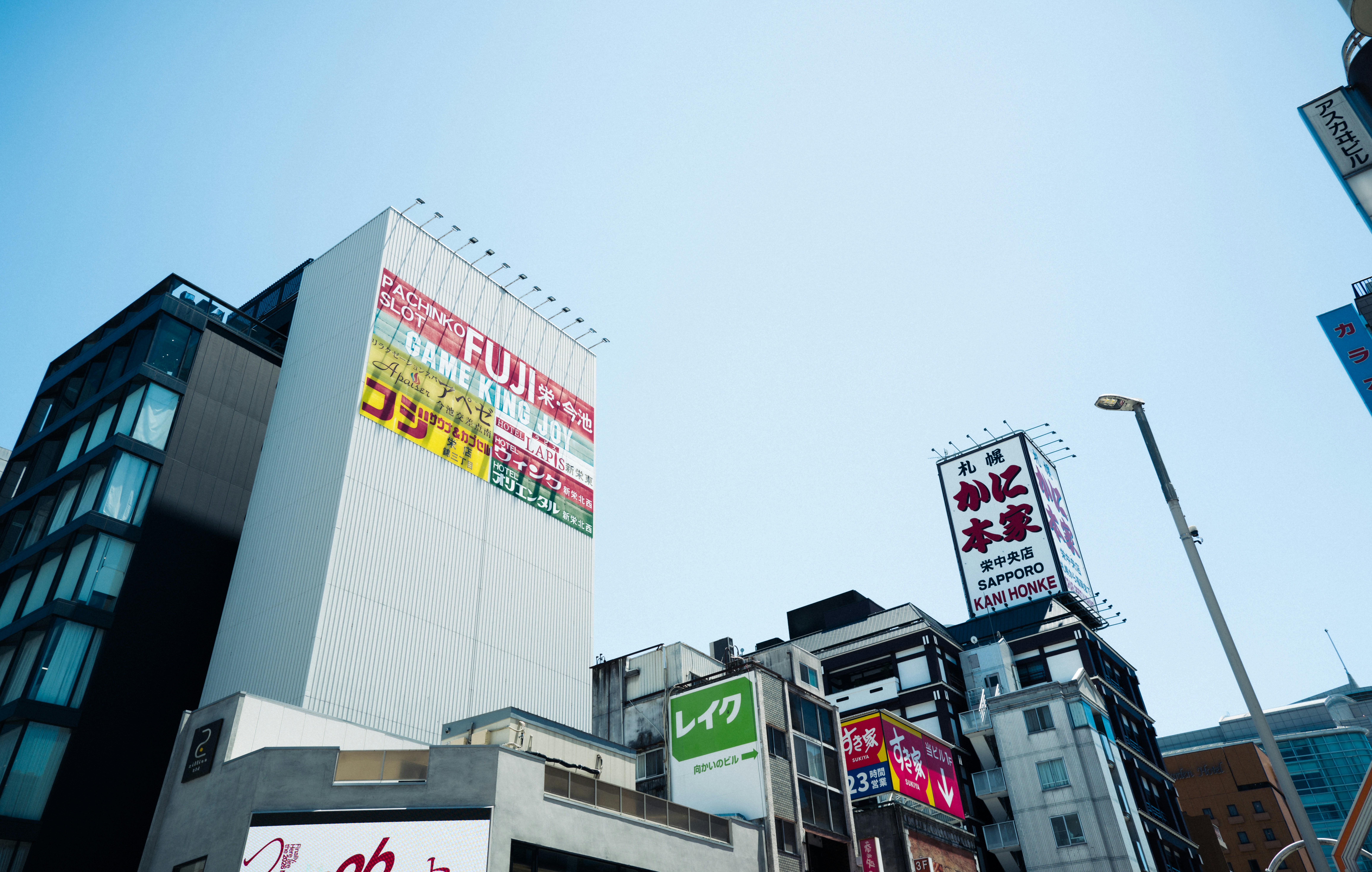 Billboards Against a Clear Sky: Tokyo’s Neon Pulse from a Street-Level Perspective