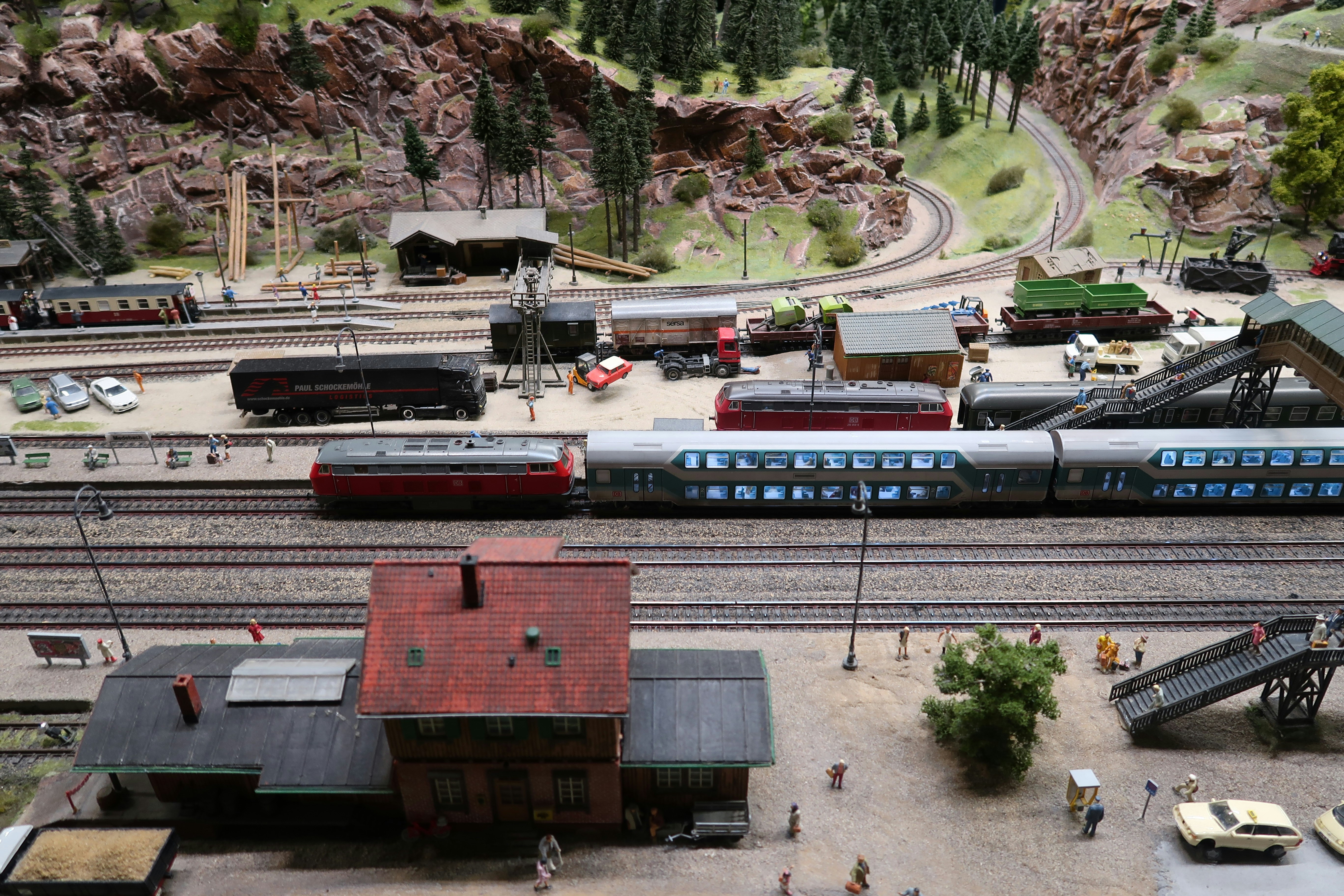 Industrial miniature: trains at a remote station with surrounding canyon scenery