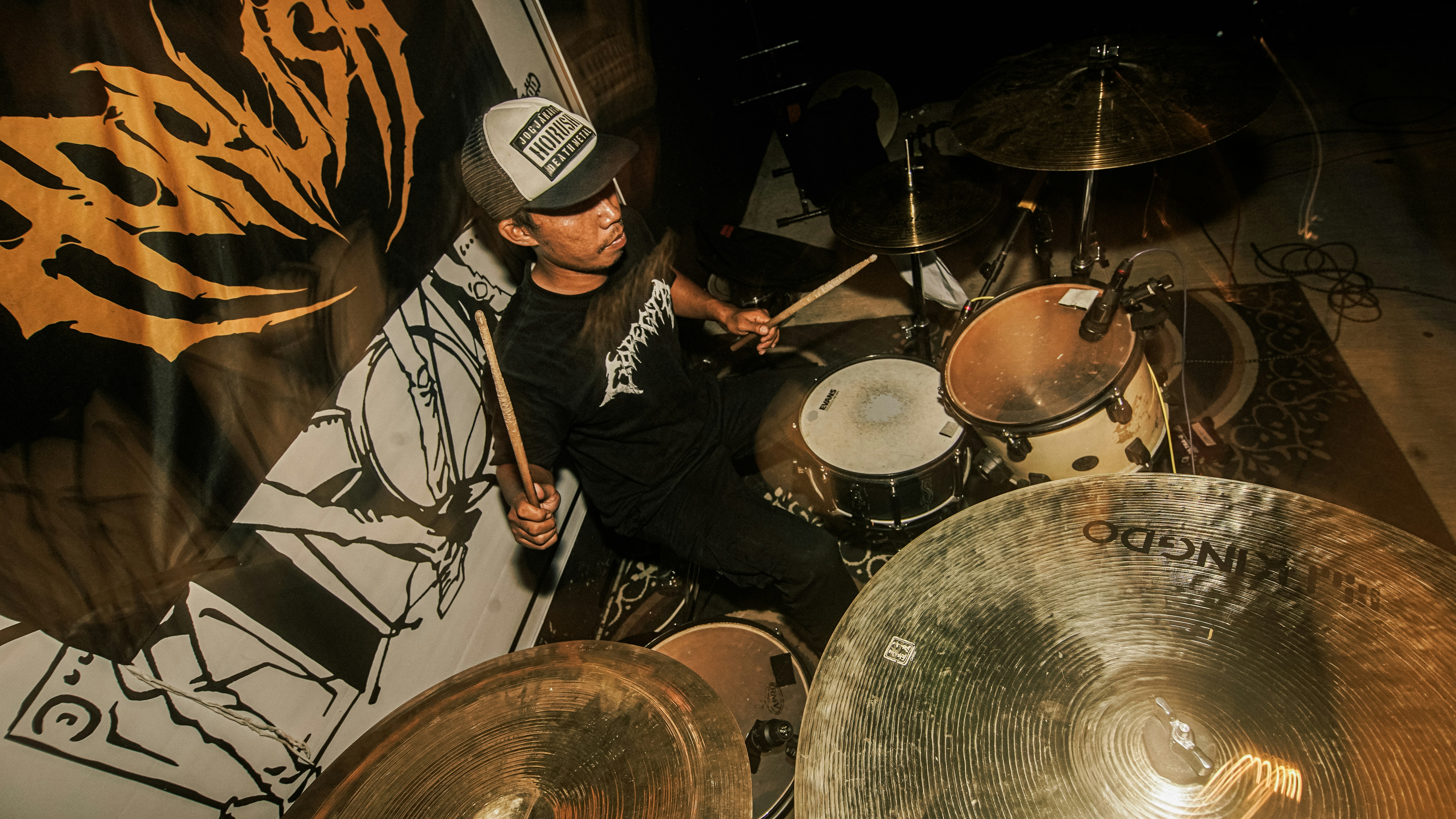 Mid‑beat Intensity: A Drummer in the Heat of a Tiny Stage