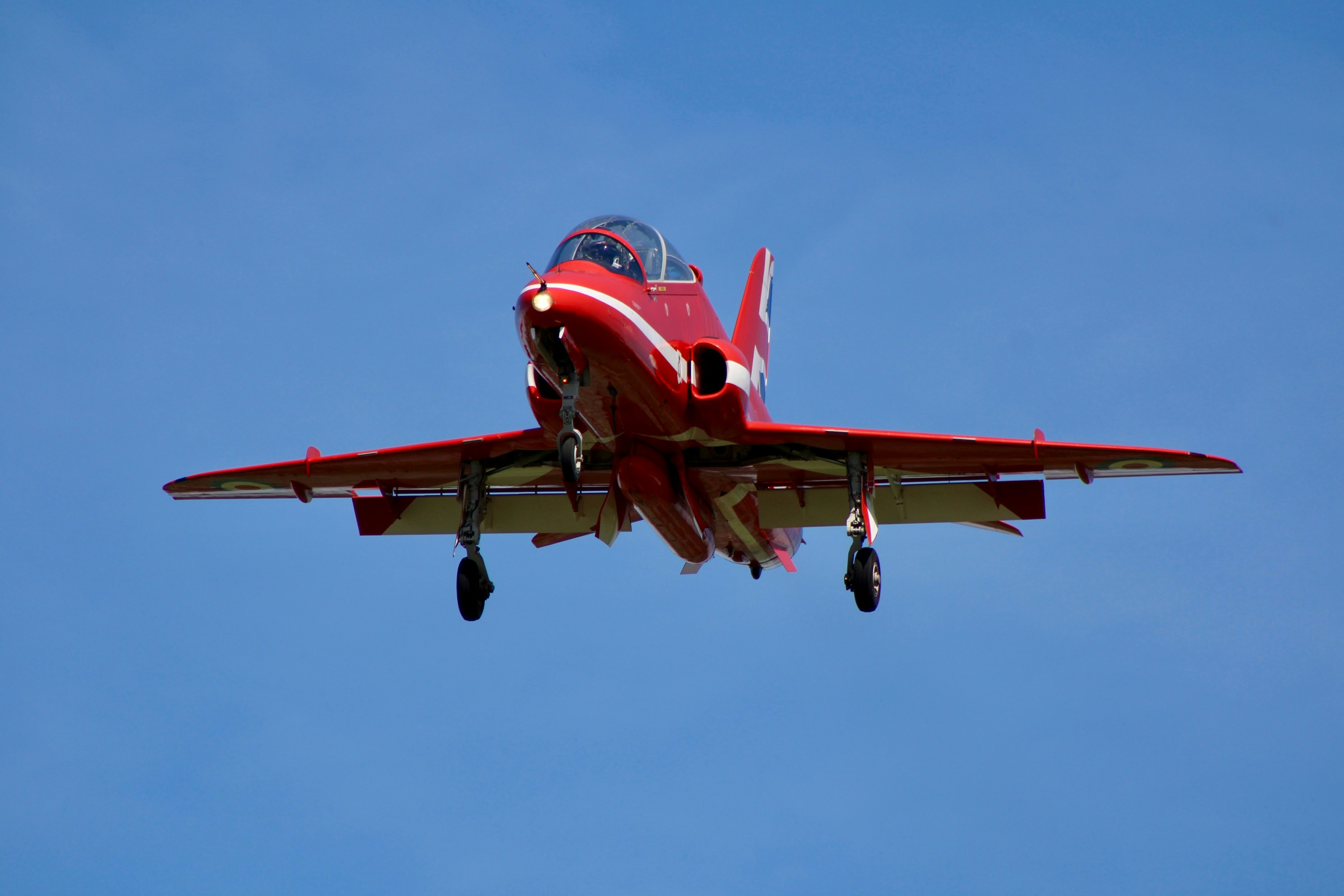 Red Jet in Clear Sky: Front-and-Center Flight