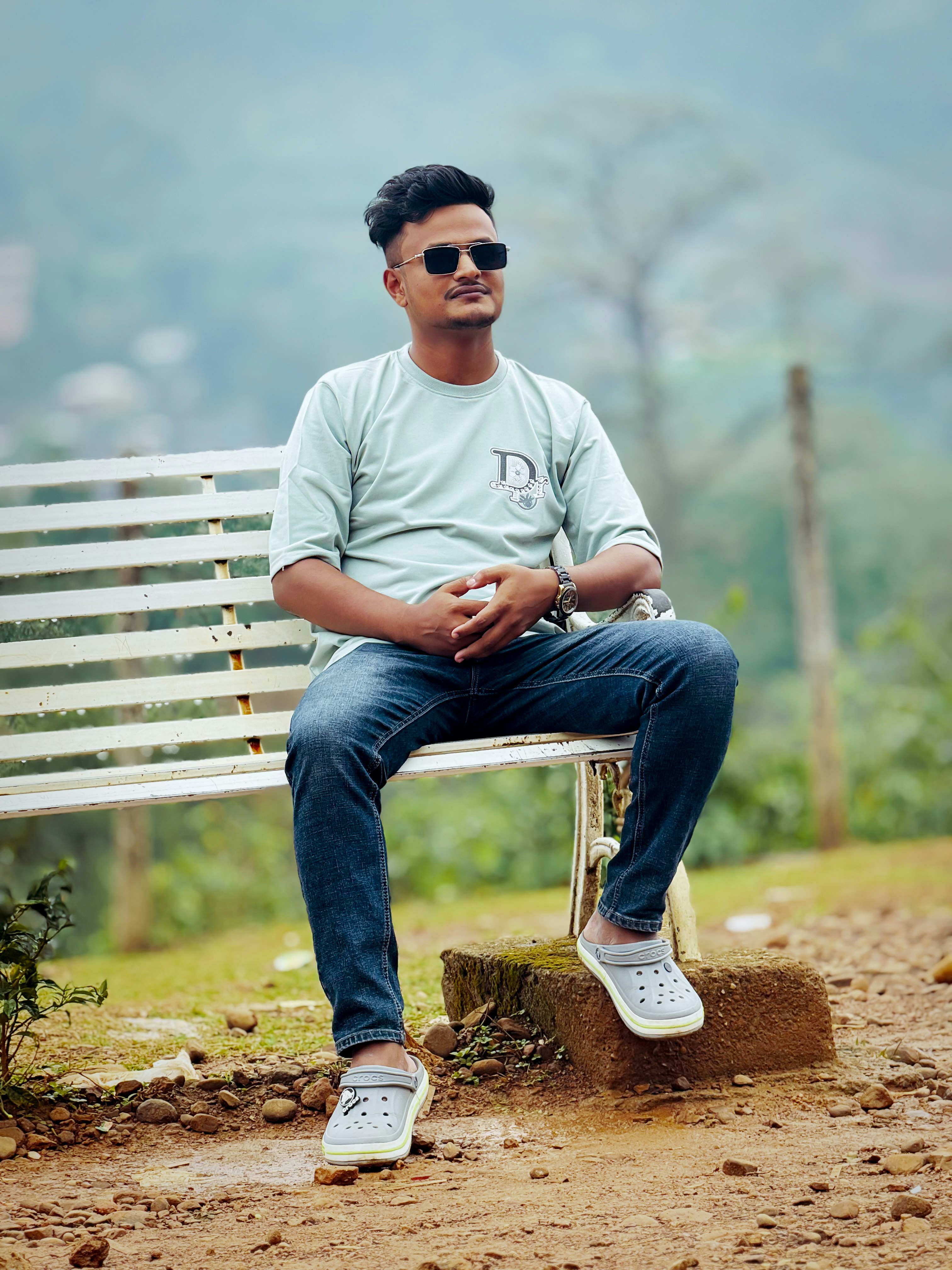 Chill Bench Moment: A Seated Portrait Under Soft Valley Light