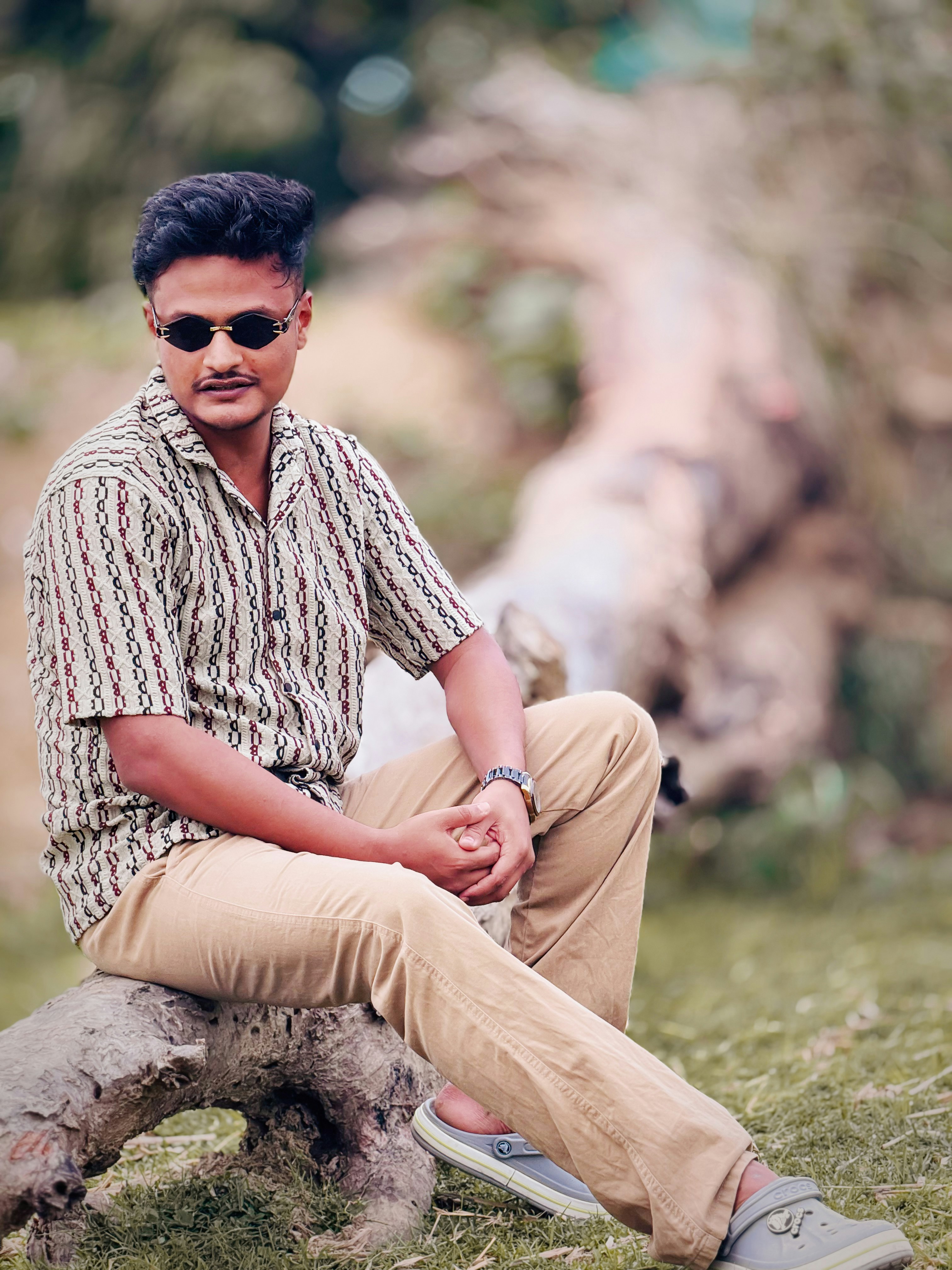Casual Confidence: Man in Patterned Shirt and Khaki Pants by a Rough-Edge Stream