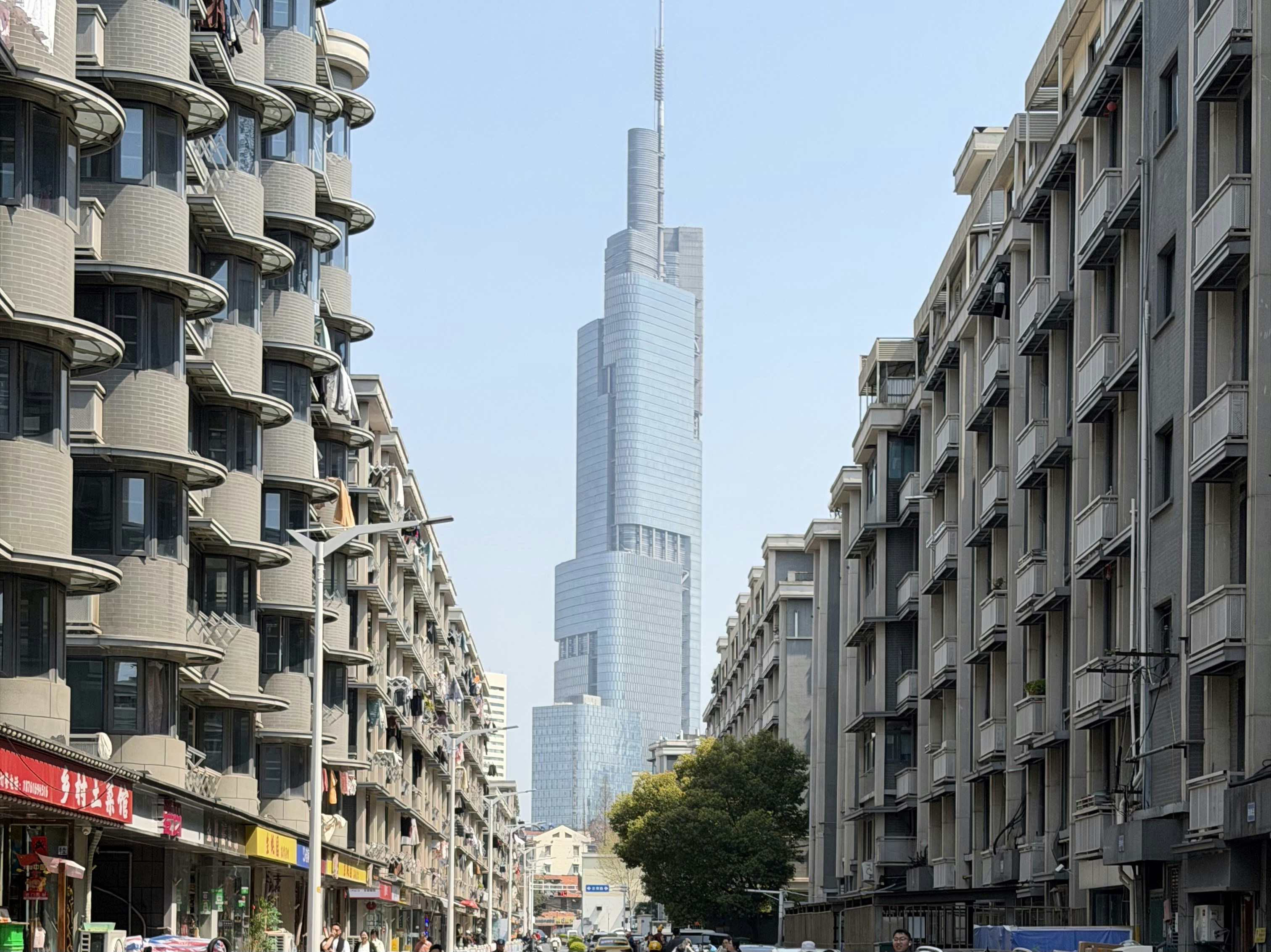 Skyline Between Balconies: Urban Avenue toward a Towering Spire