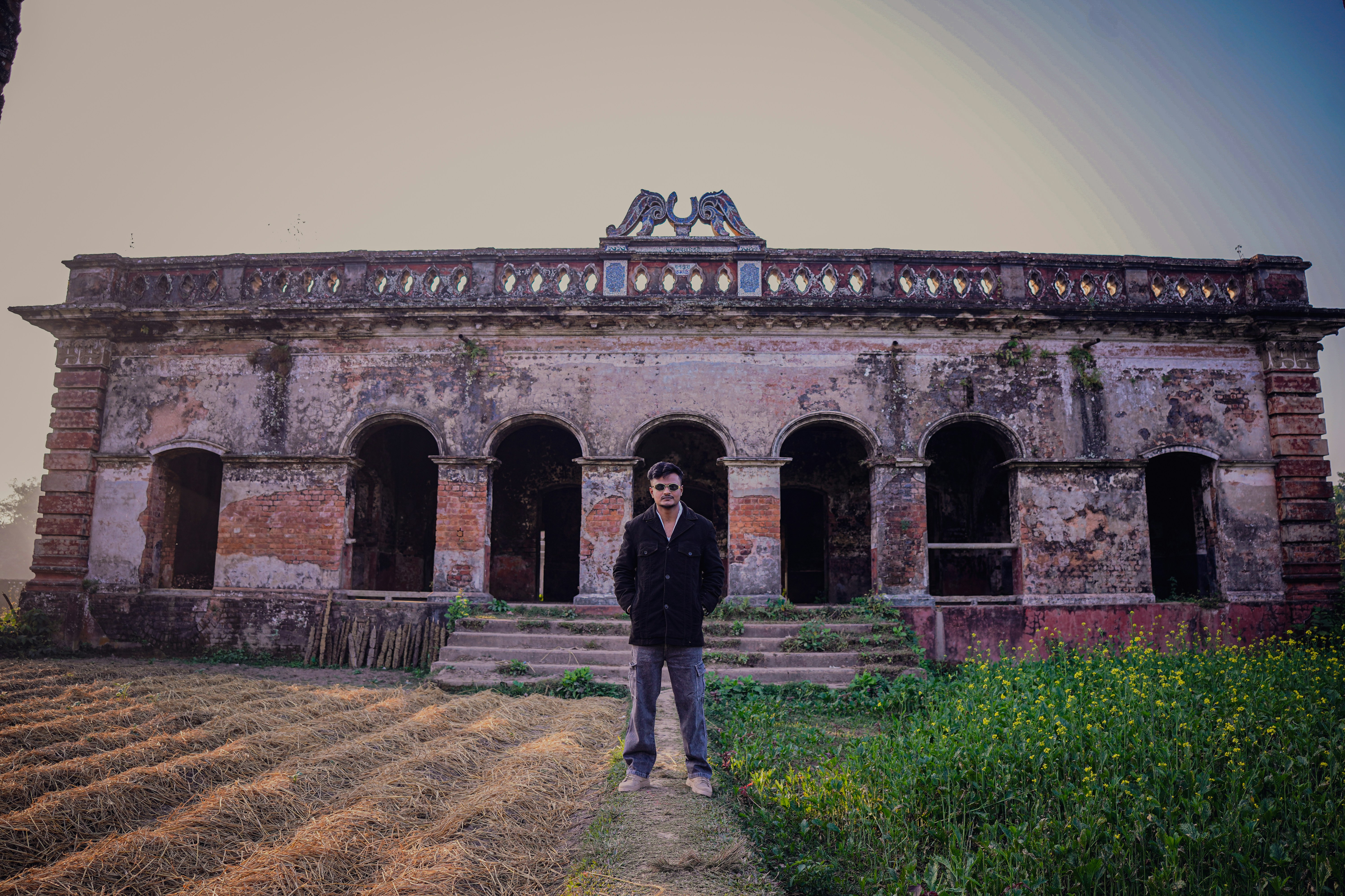 Traveler at the Ruined Arcade Aligned with Timeworn Facade