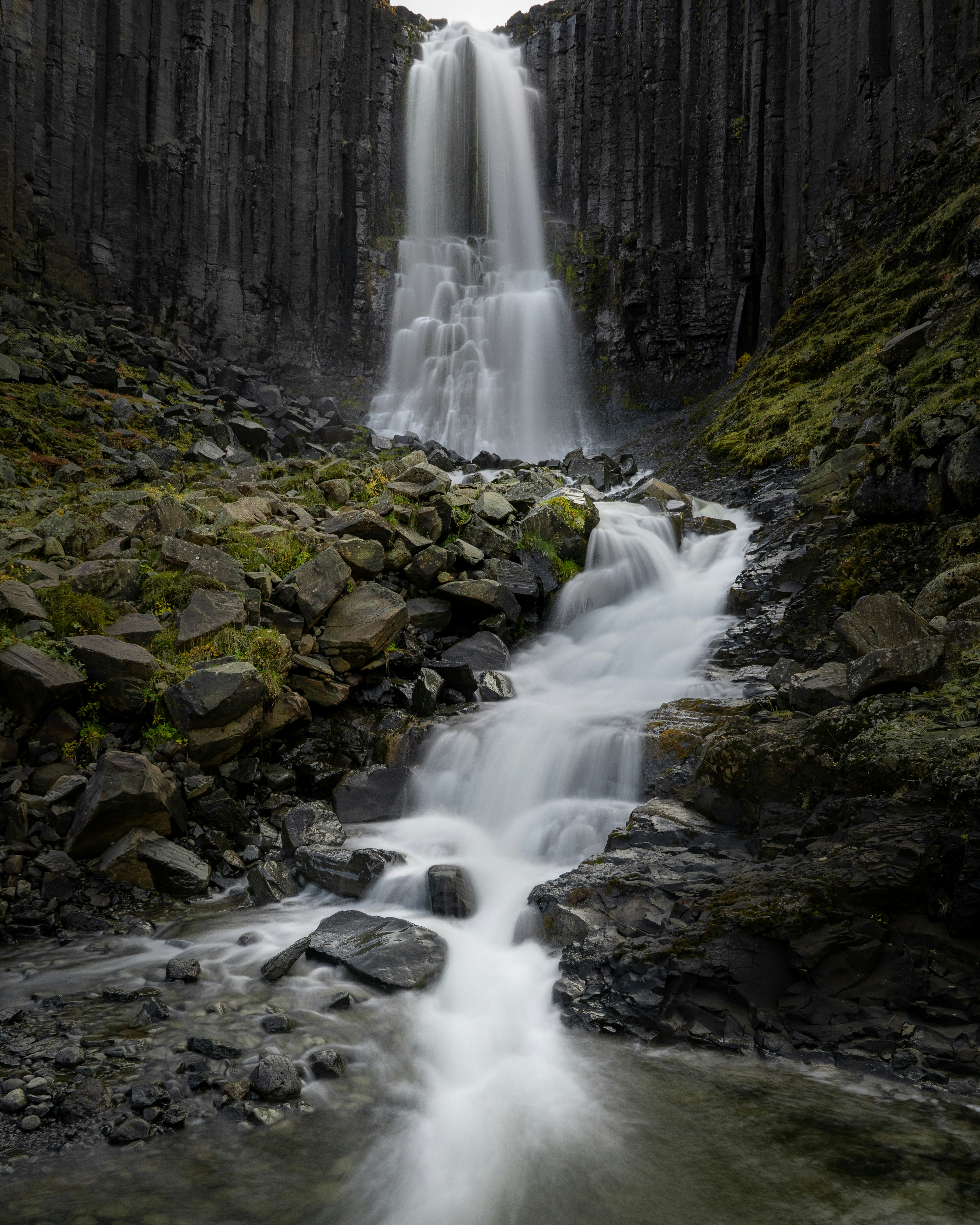 Icy Cascade Through Basalt Veins